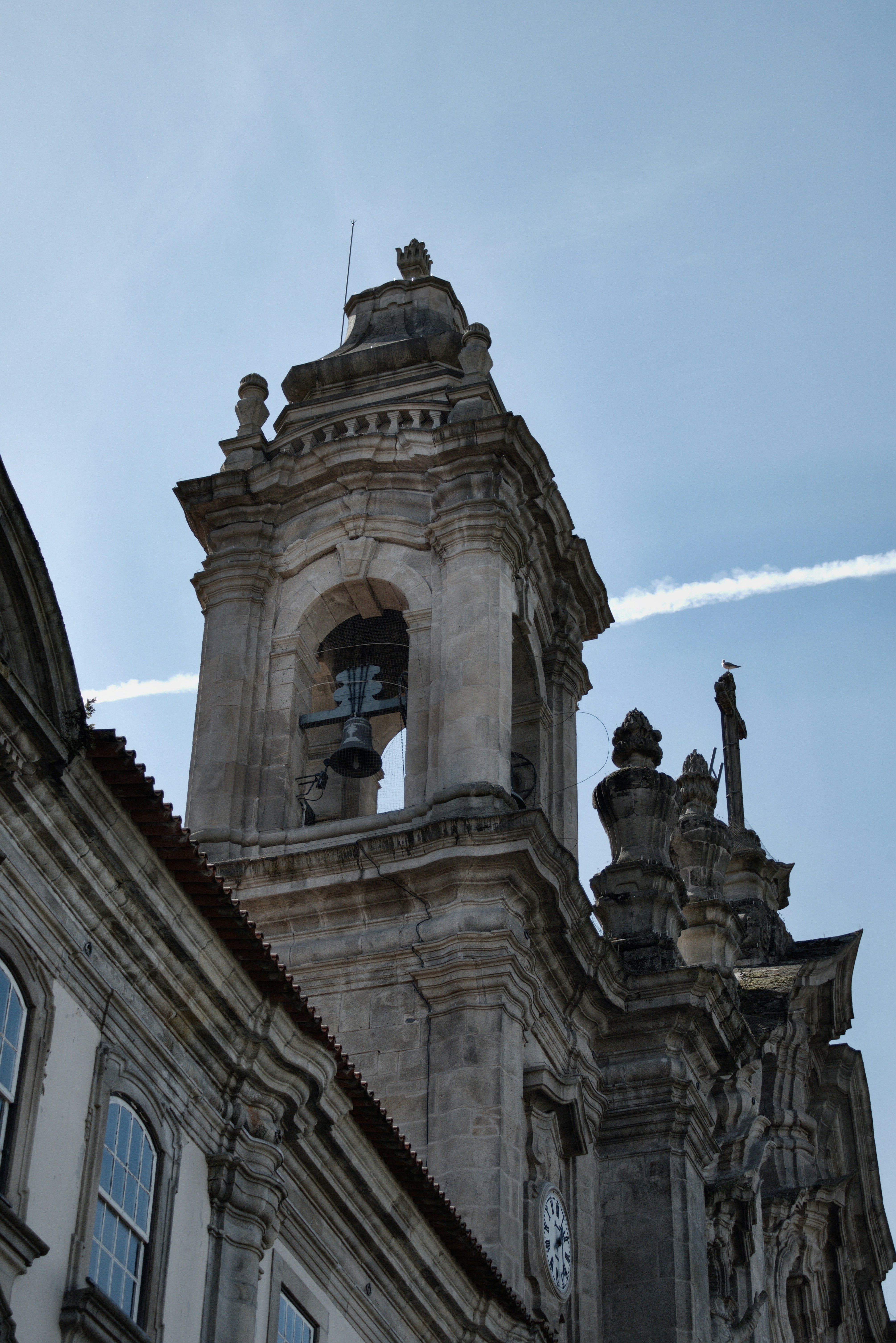 Baroque Bell Tower Emerges from a Stone Facade Under a Crystal Sky