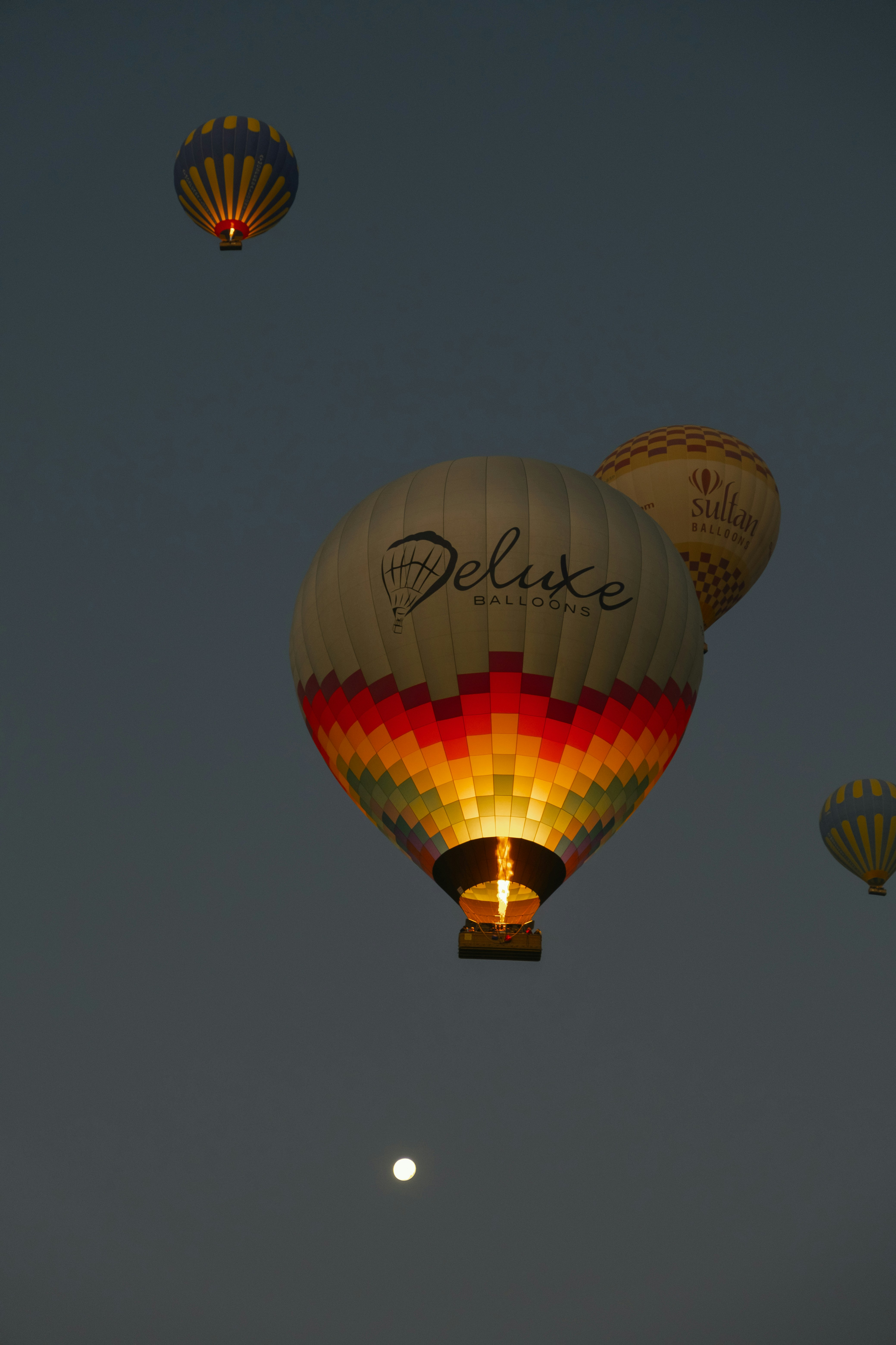 Deluxe Balloons at Dusk: A Rainbow Quilt Drifts Across Twilight