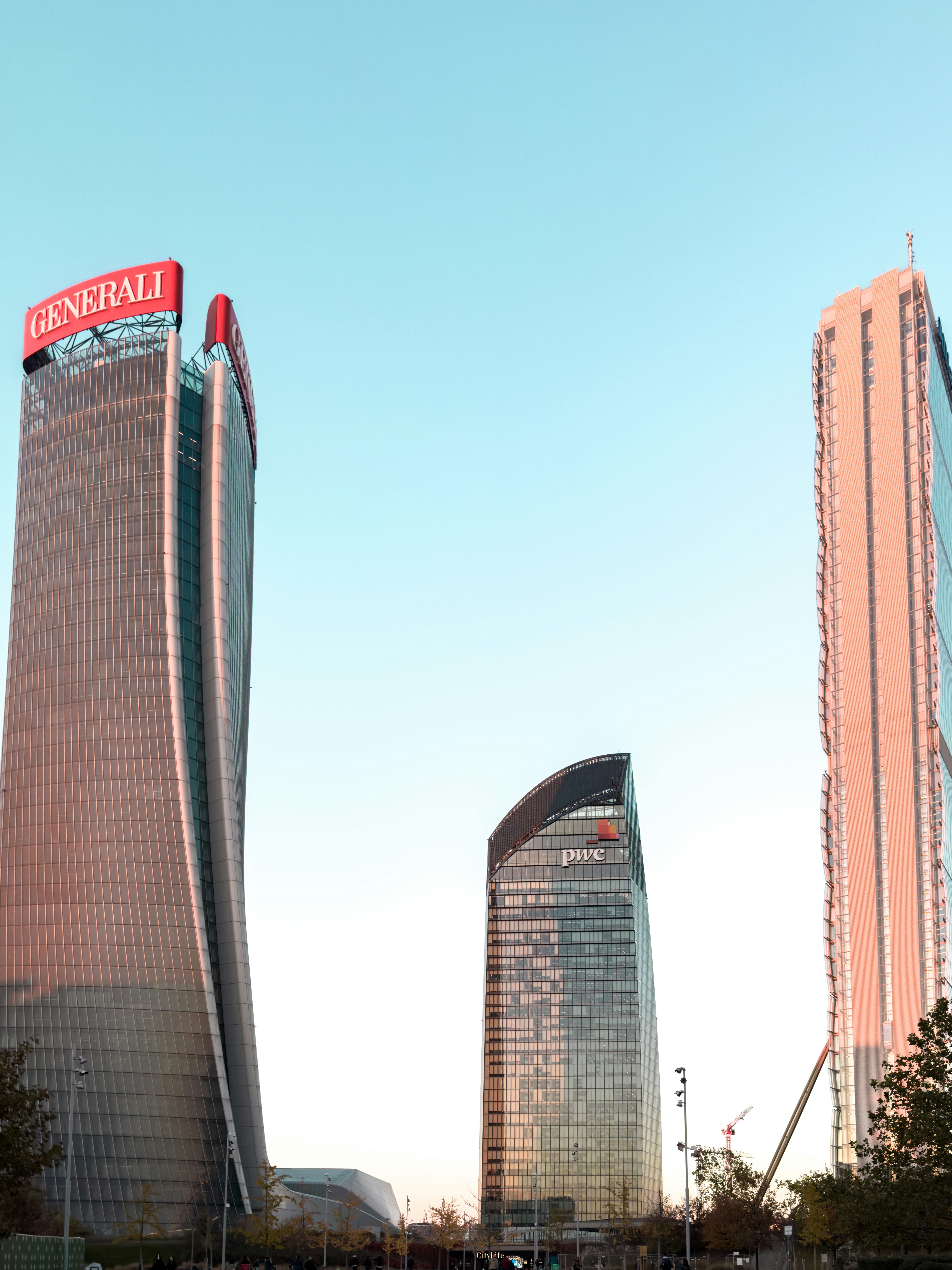 Cerulean Skyline: Generali and PwC Glass Giants Under a Clear Sky