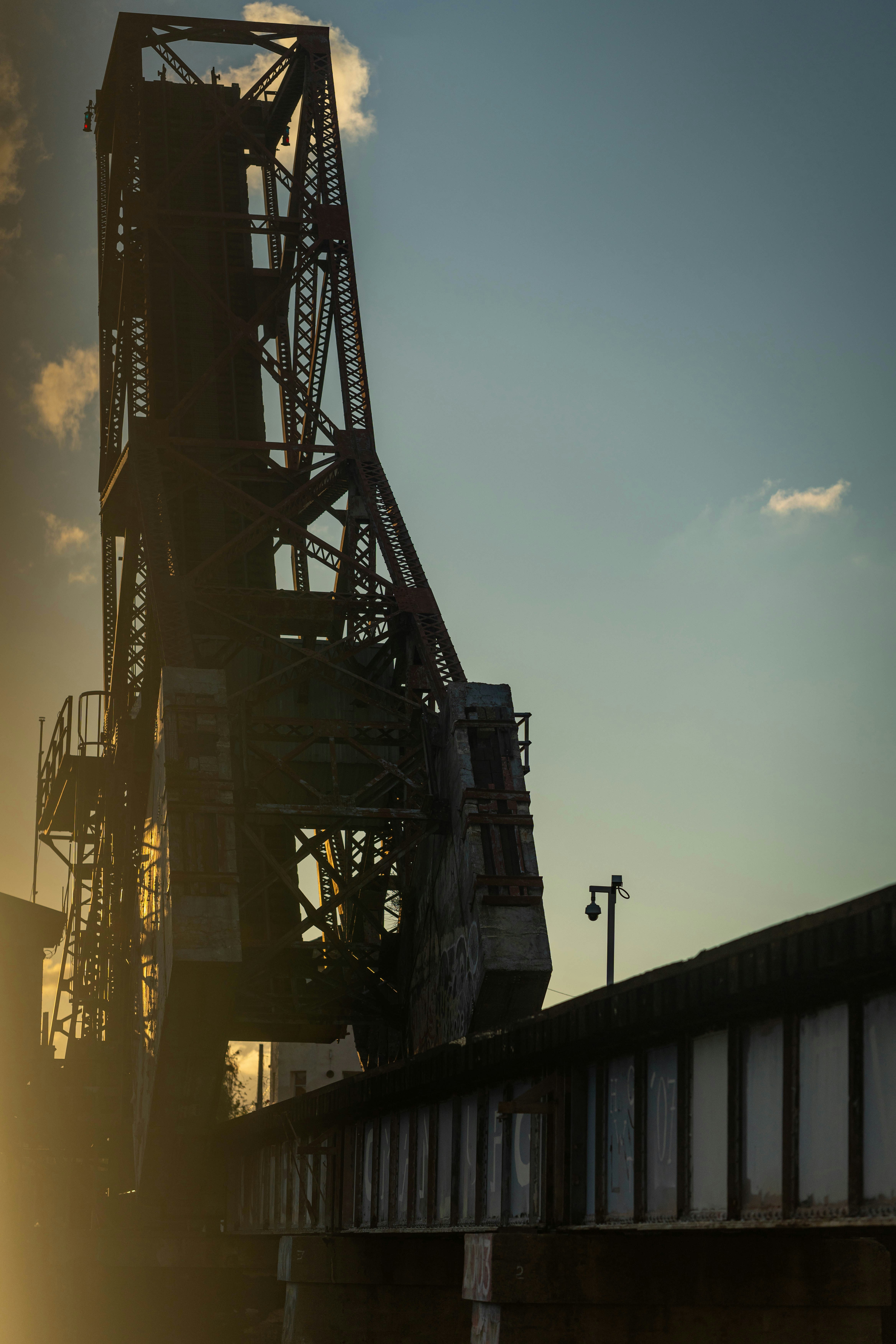 Sunlit Lift: A towering steel structure cut against a soft evening glow