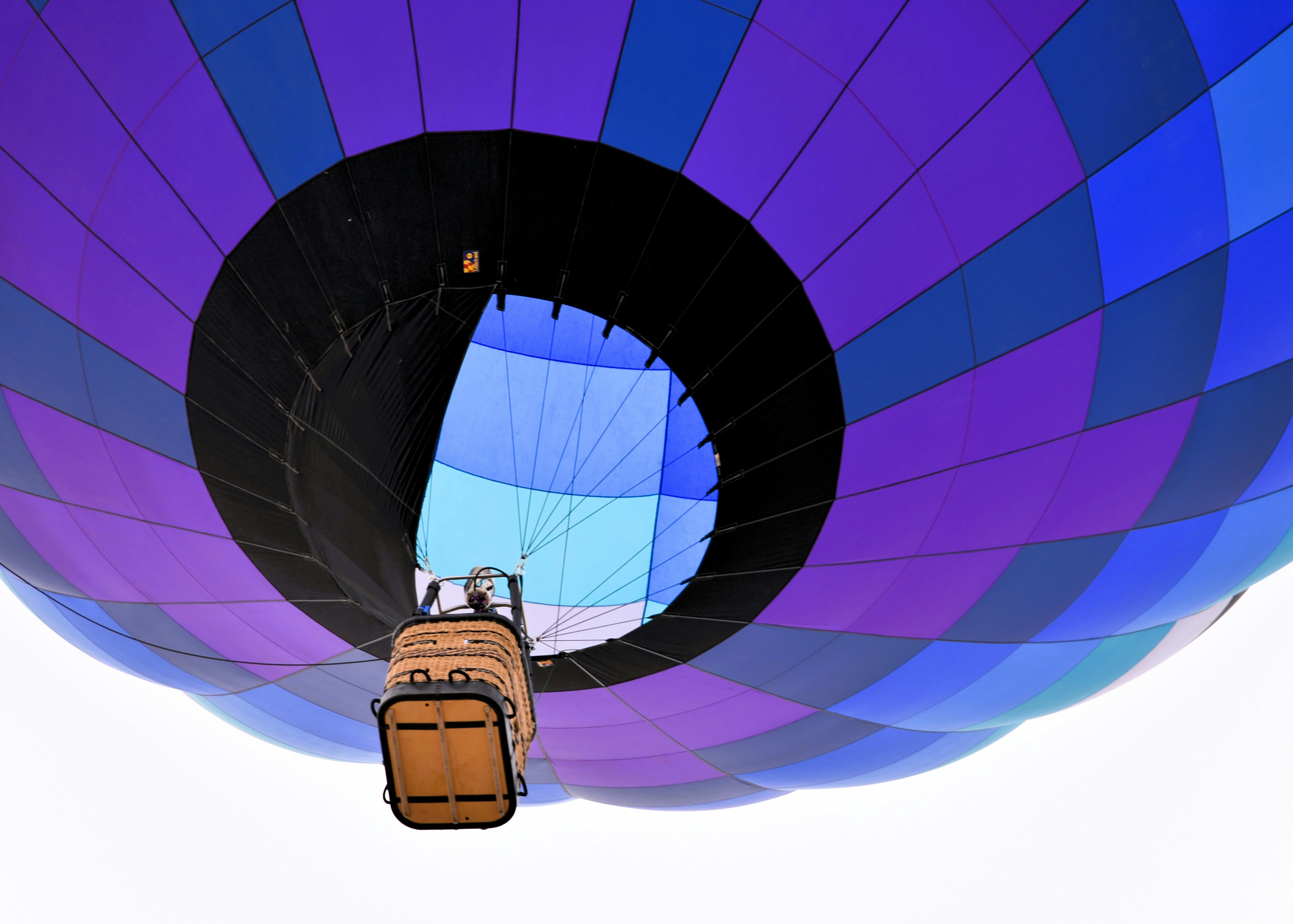 Basket Beneath a Violet Halo: A Balloon Encircling the Sky