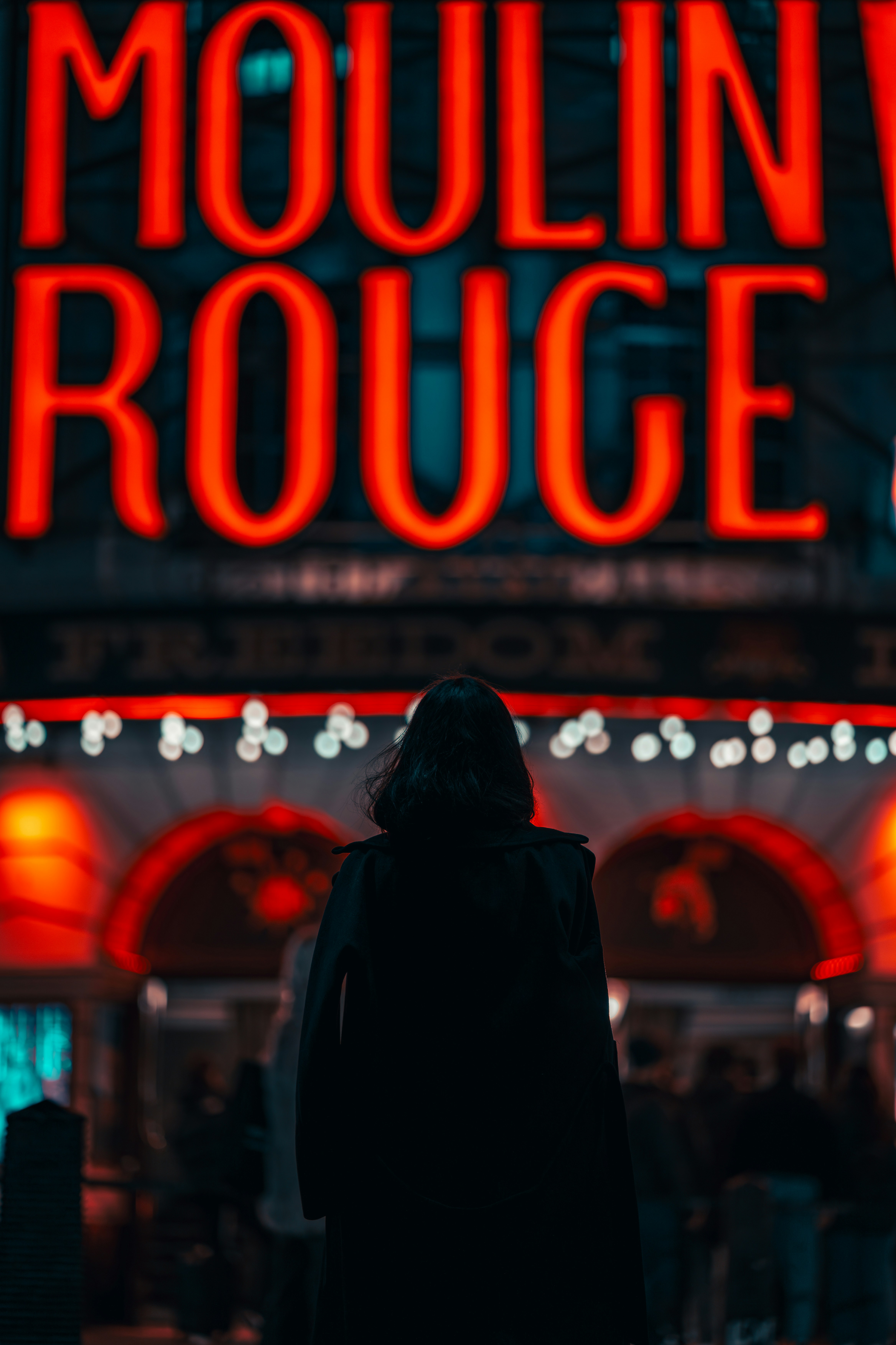 Crimson Veil: A Night Silhouette Before Moulin Rouge Neon