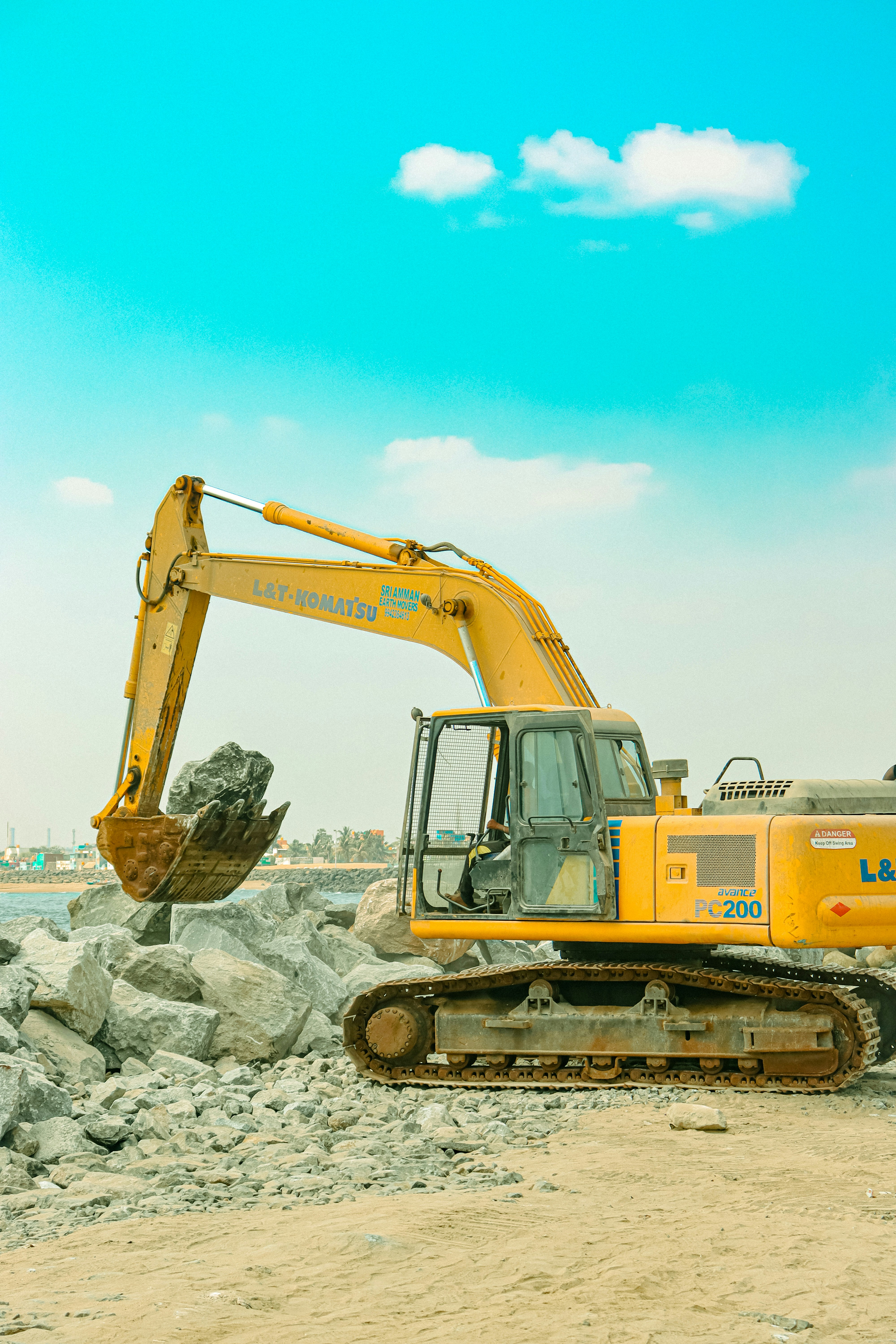 A yellow bulldozer is parked on a beach photo – Free Bulldozer Image on ...