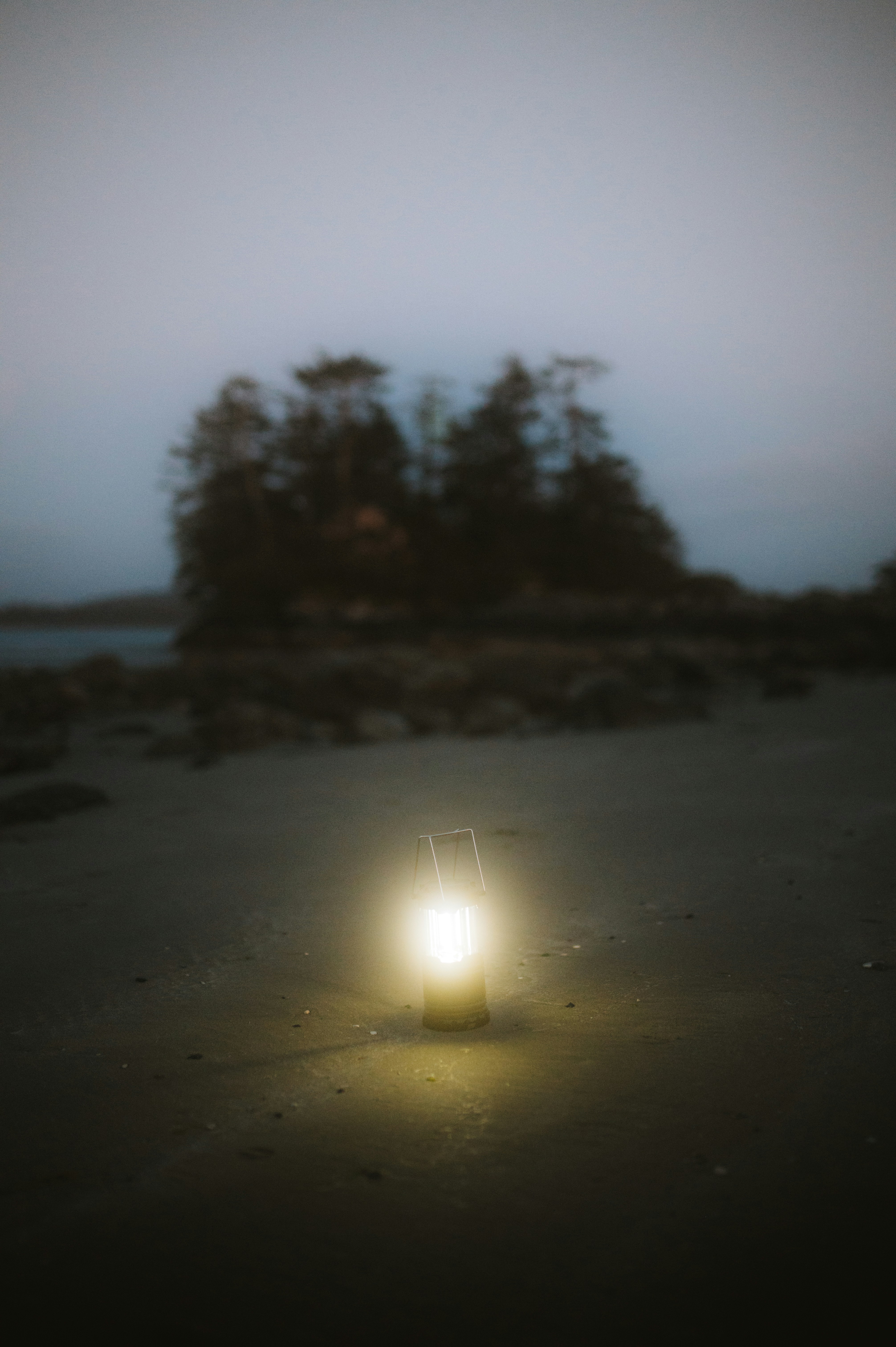 Lantern on a Quiet Beach Beneath Twilight