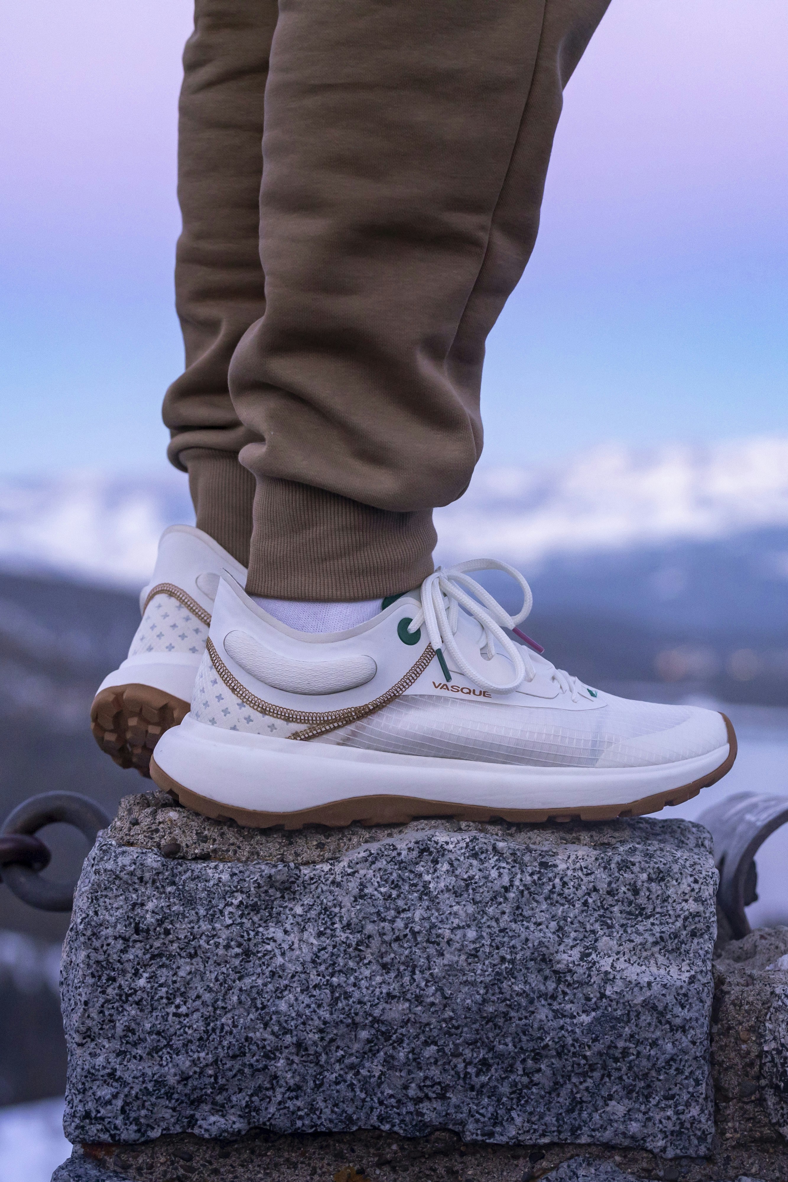 Edge of Focus: White Sneaker Anchored on Granite at a Mountain Overlook
