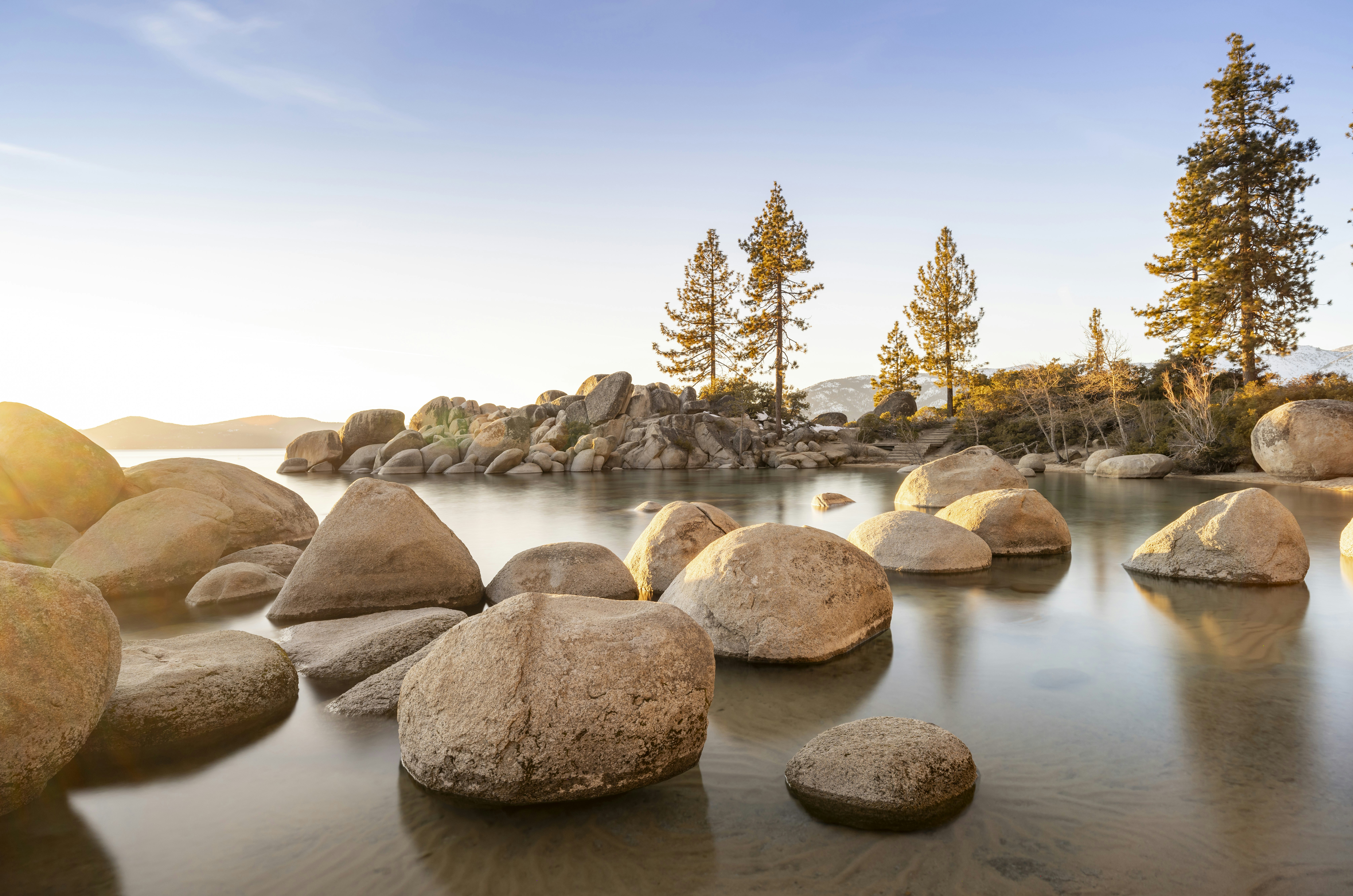 A group of rocks sitting on top of a body of water photo – Free Rock ...