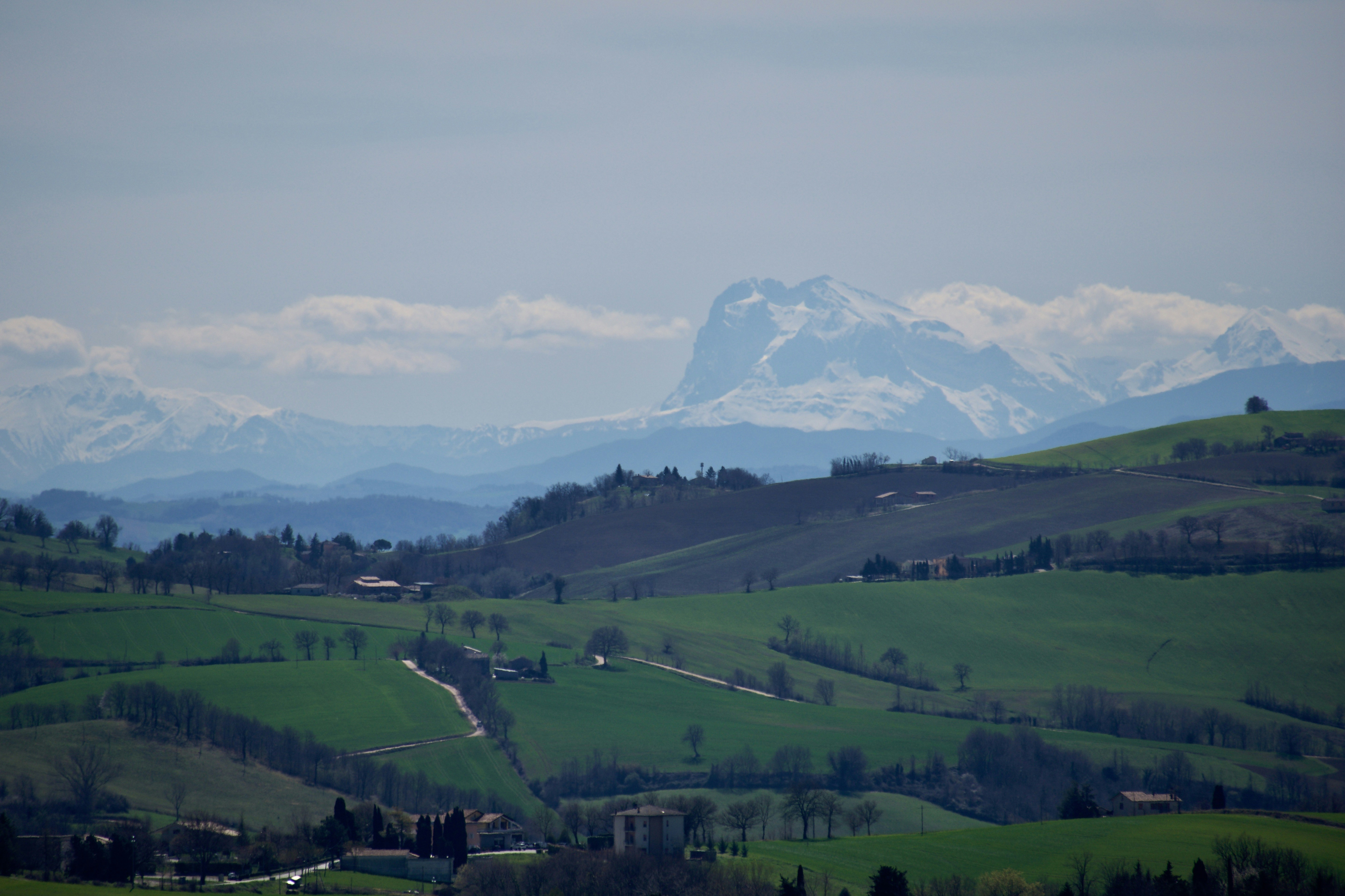Snow-kissed Peak Framed by Patchwork Hills
