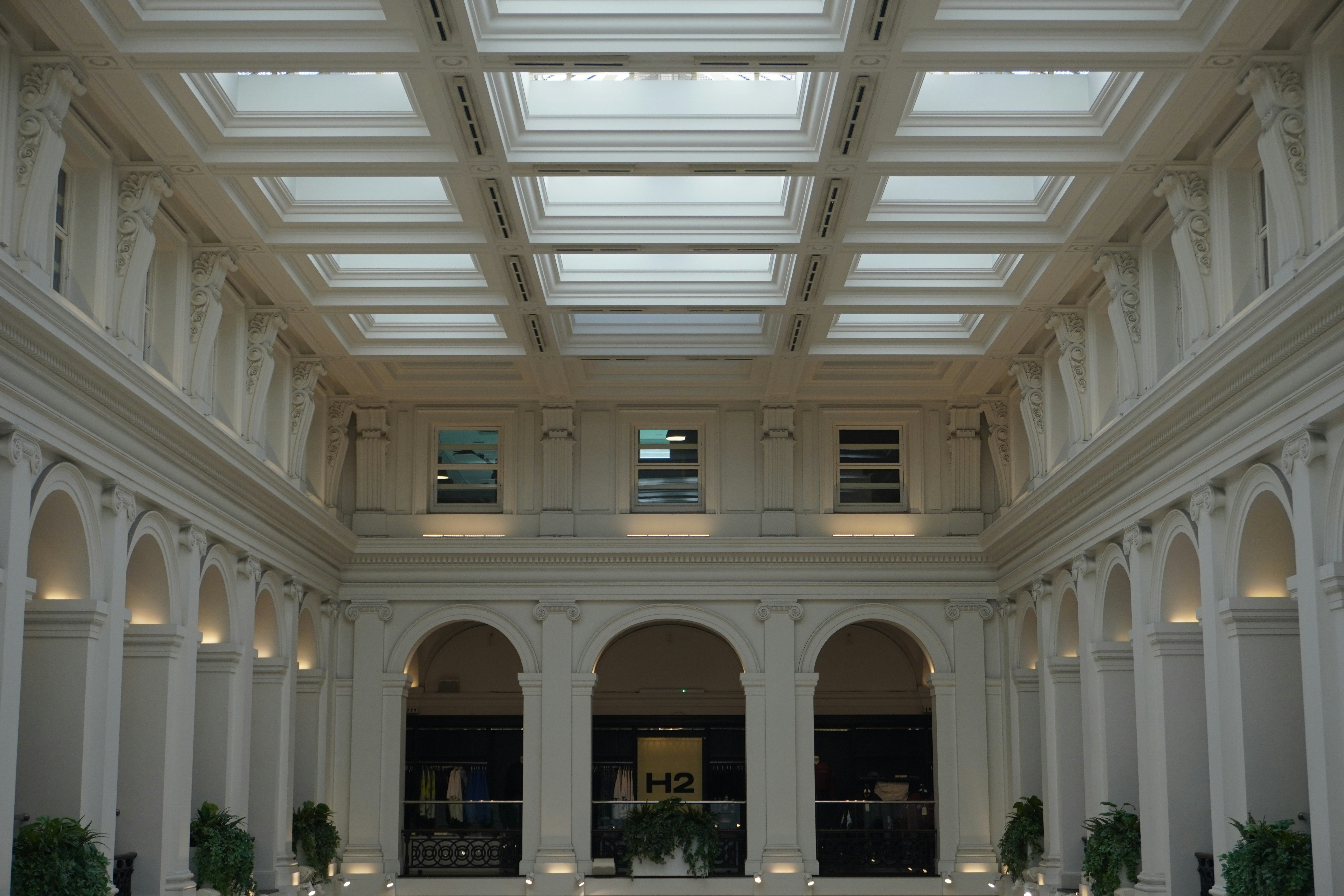 A large building with a lot of columns and windows photo – Free ...