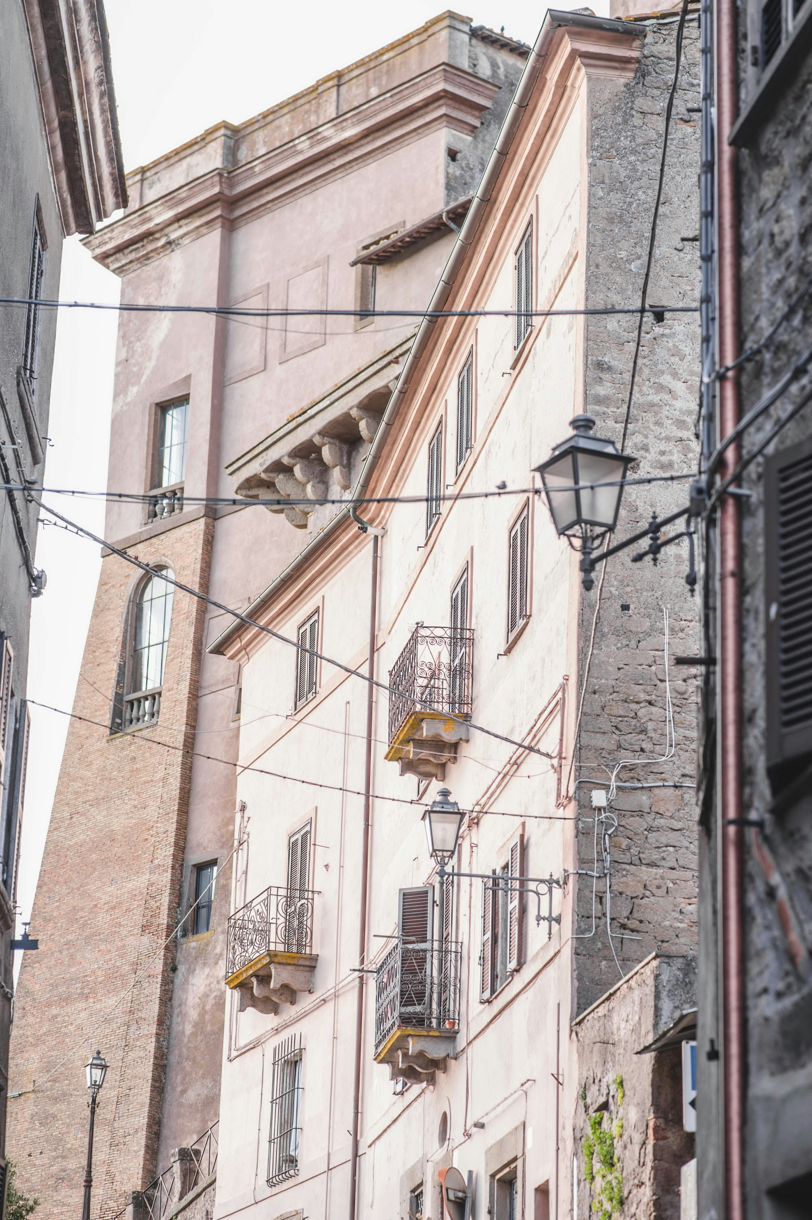 Balconies, Wires, and Sunlit Facades: A Narrow European Street