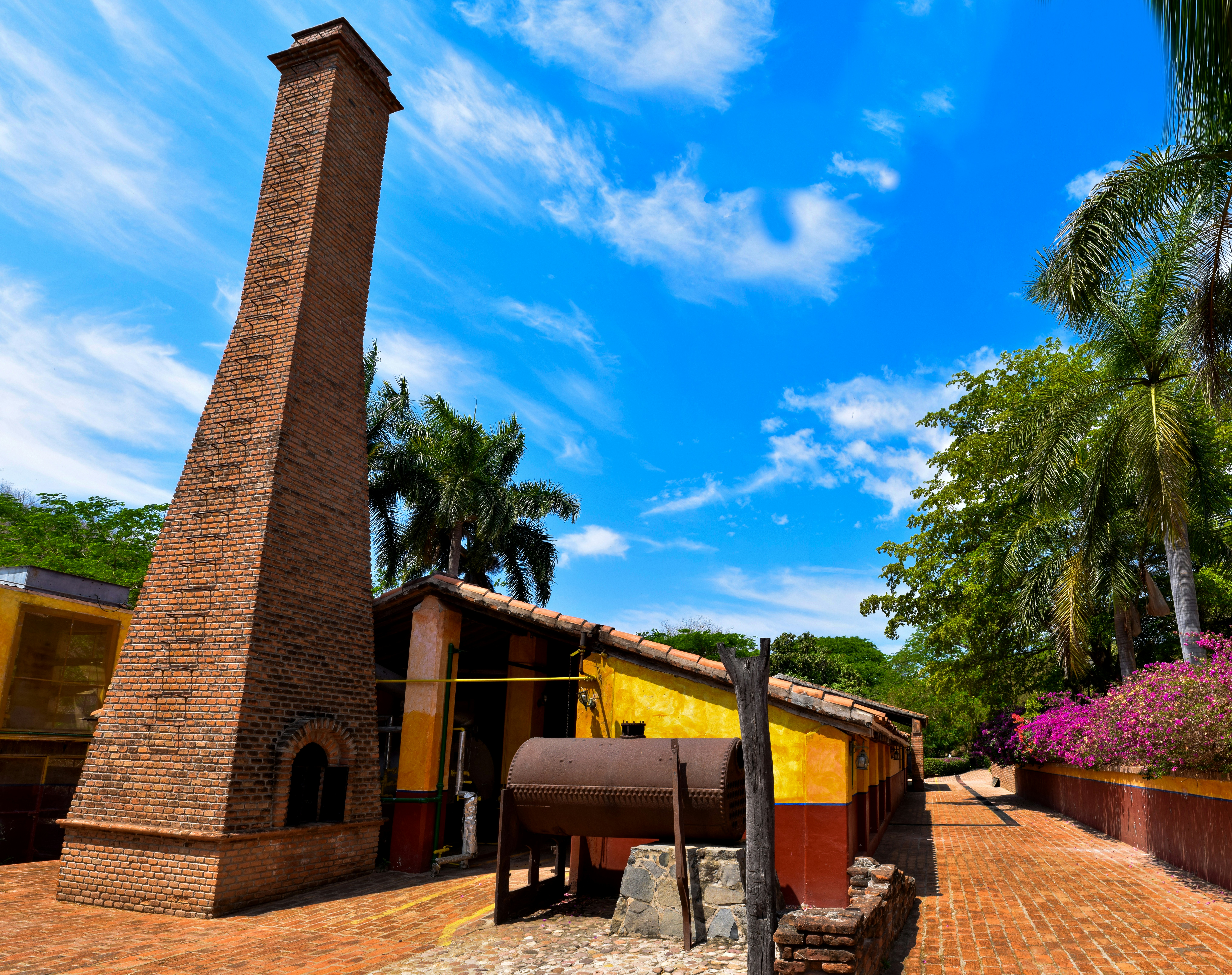 Sunlit Brick Chimney Over a Palm-Fringed Courtyard