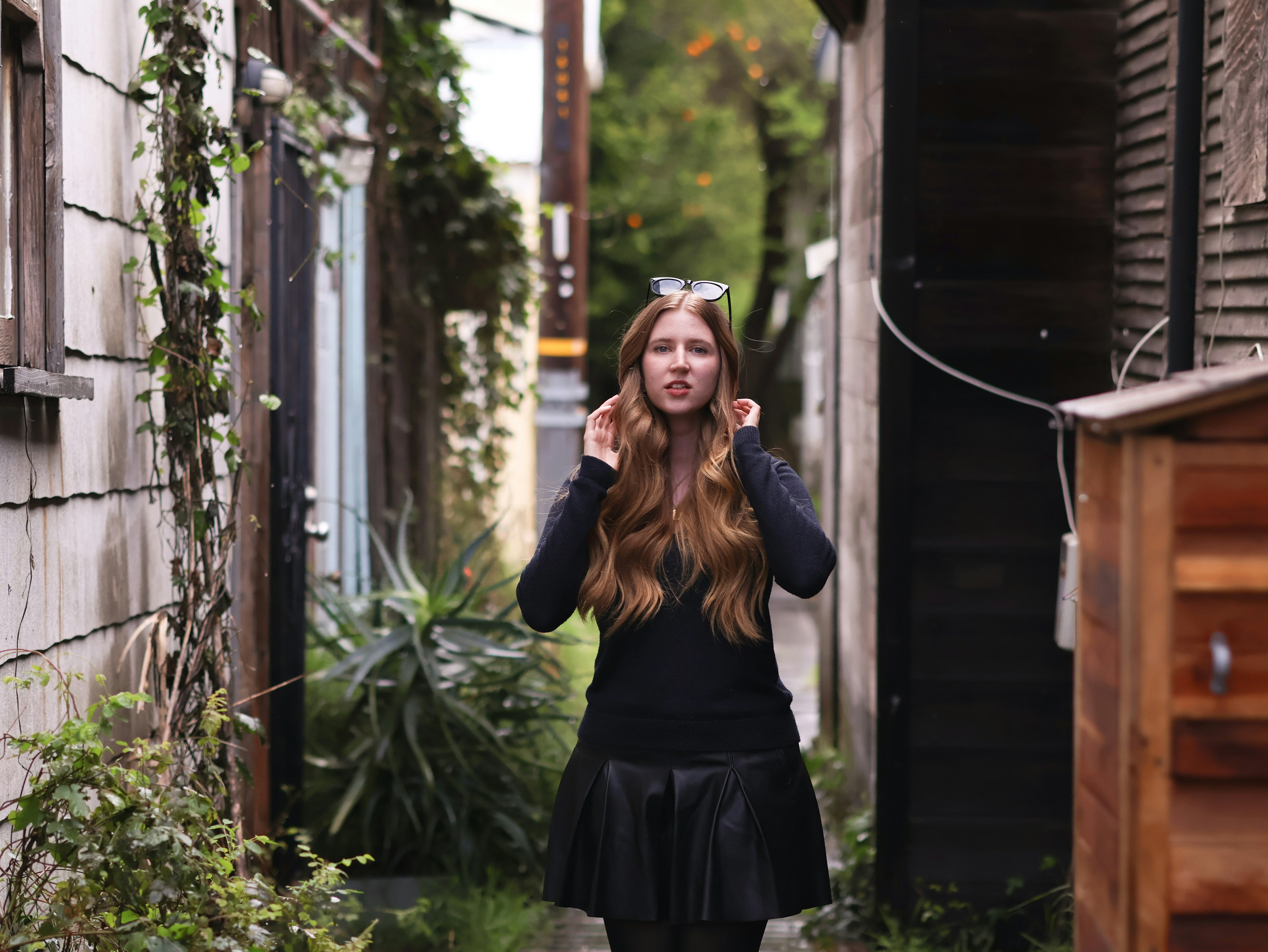 a woman with long hair wearing a black dress