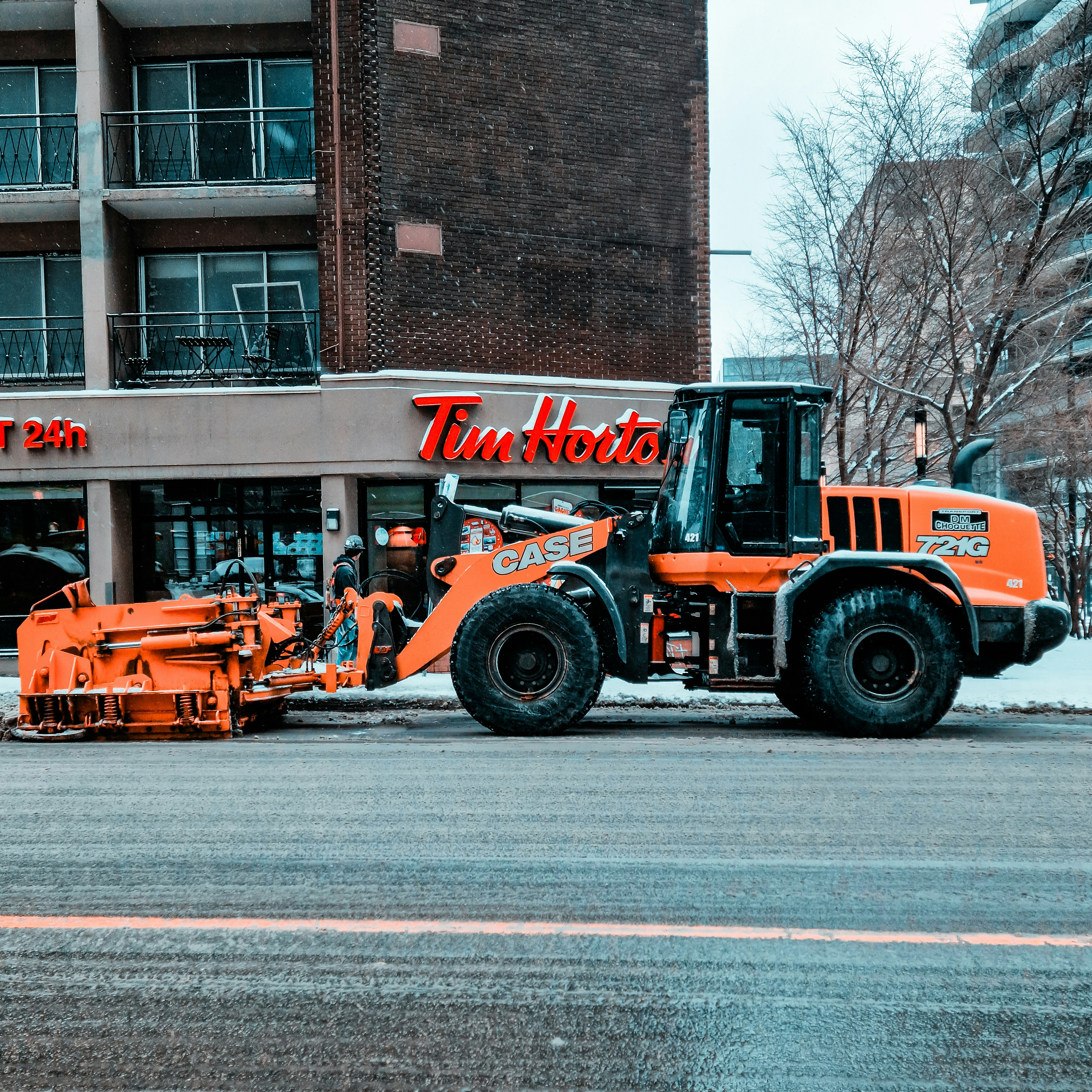 Orange Power on a Snowy Streetfront: CASE Loader by Tim Hortons