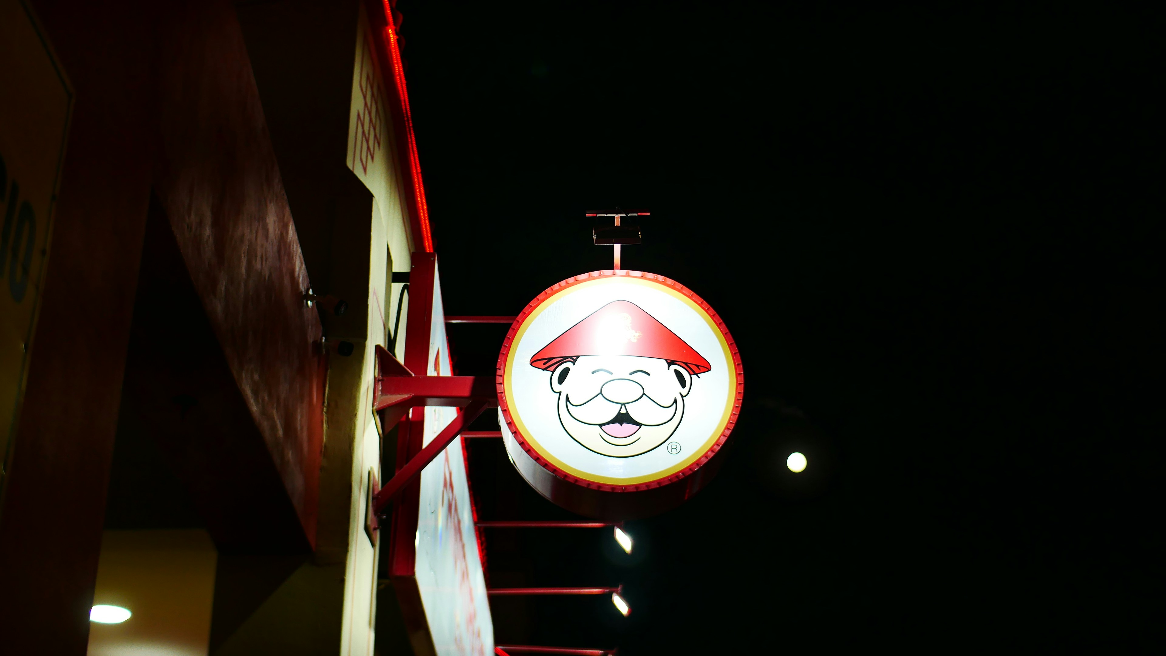 Santa’s Round Emblem Glows Over a Silent Night Street