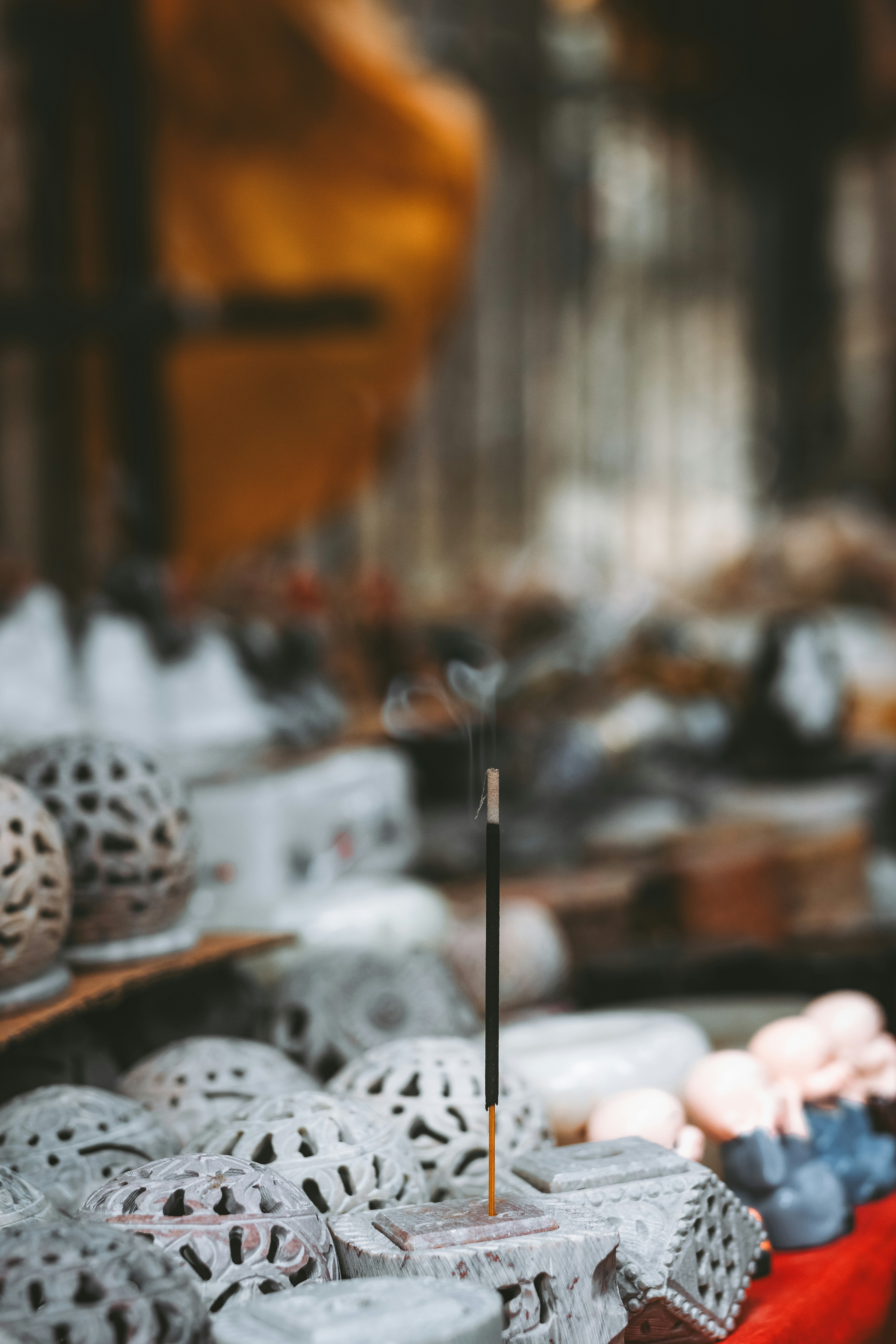 Incense Amid Carved Lanterns at a Market Stall