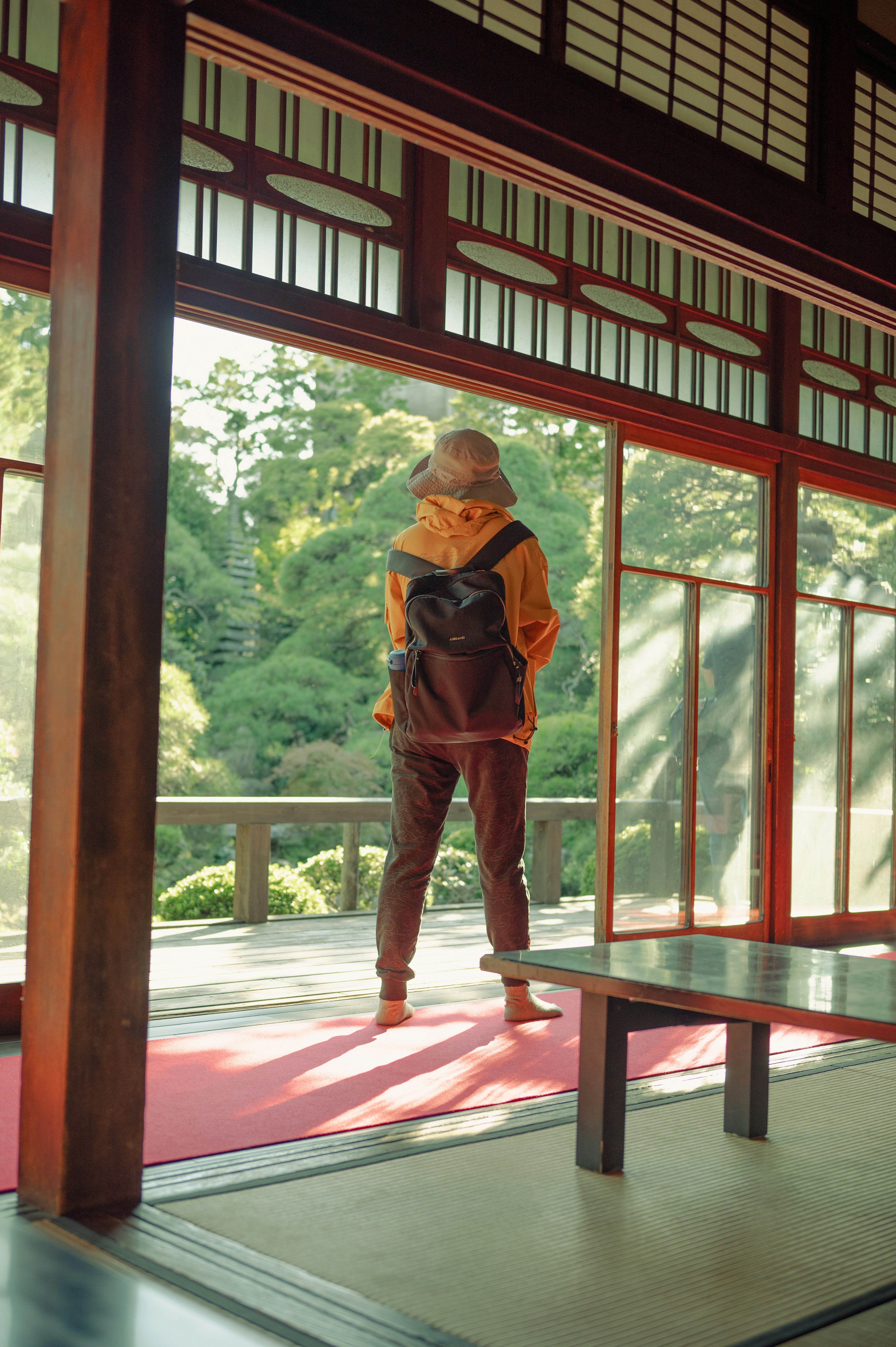 Traveler in a Sunlit Temple Corridor