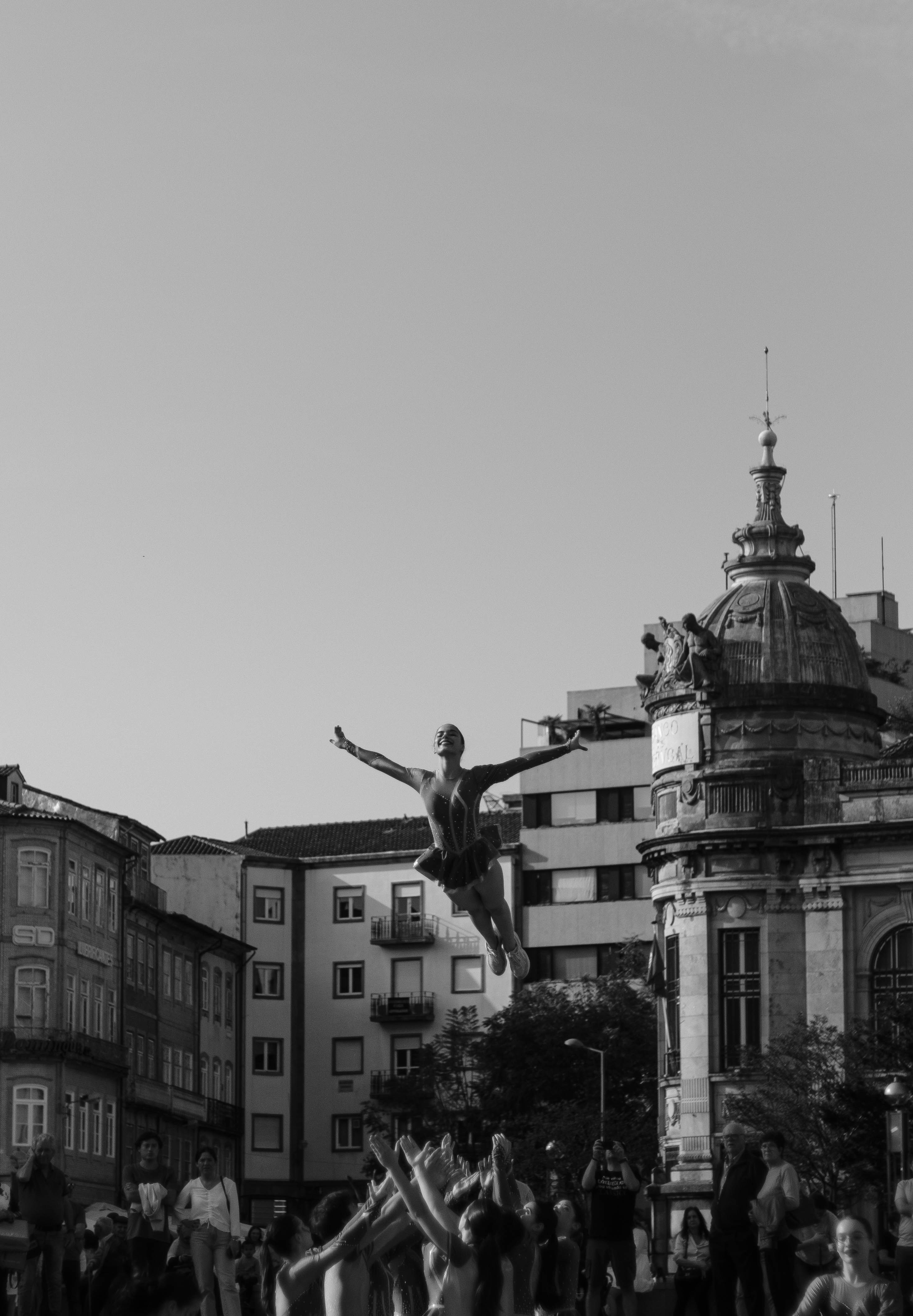 Mid-Air in the City Square: A Dancer's Leap Over the Crowd