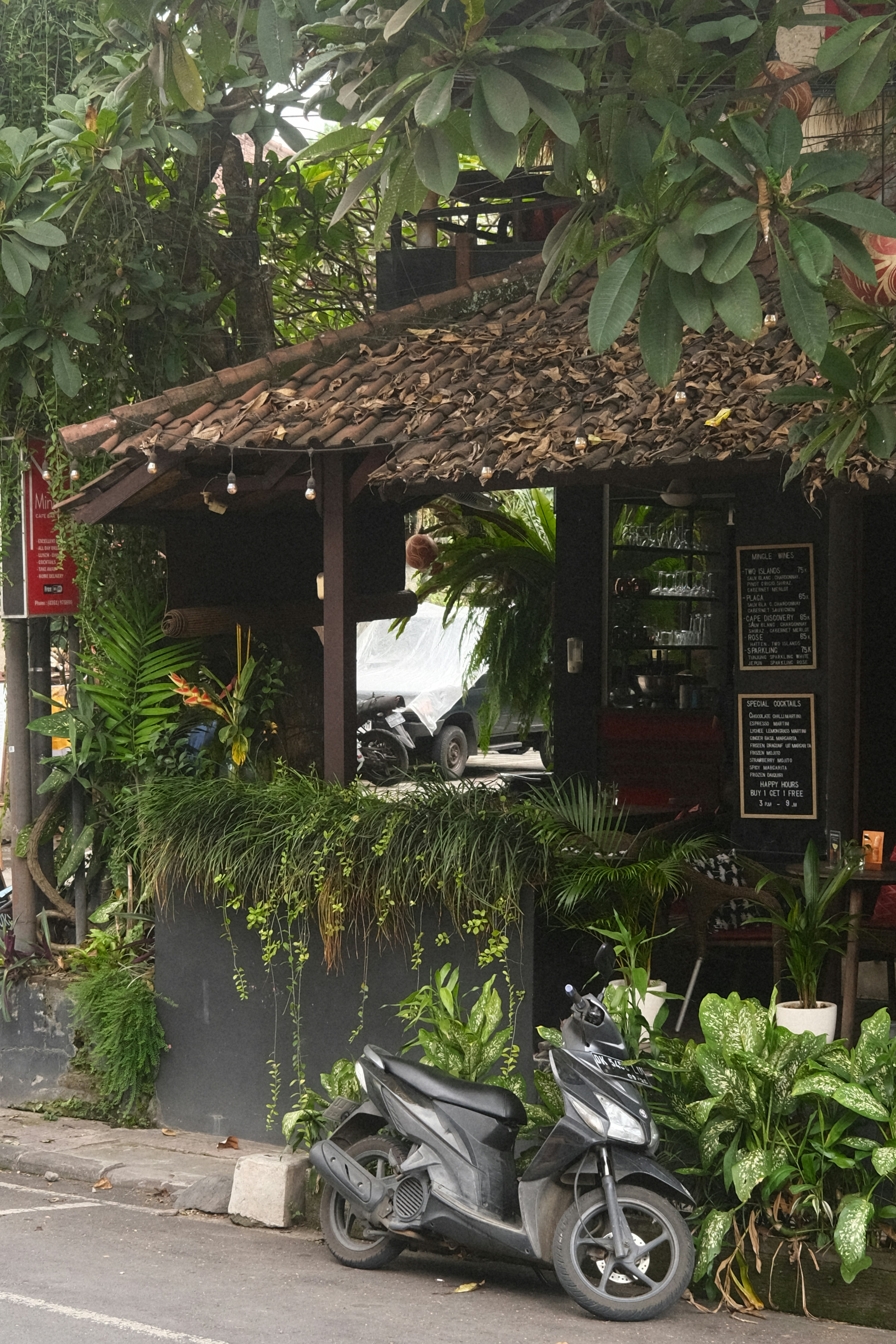 Scooter Pauses by a Verdant Street Café Nook