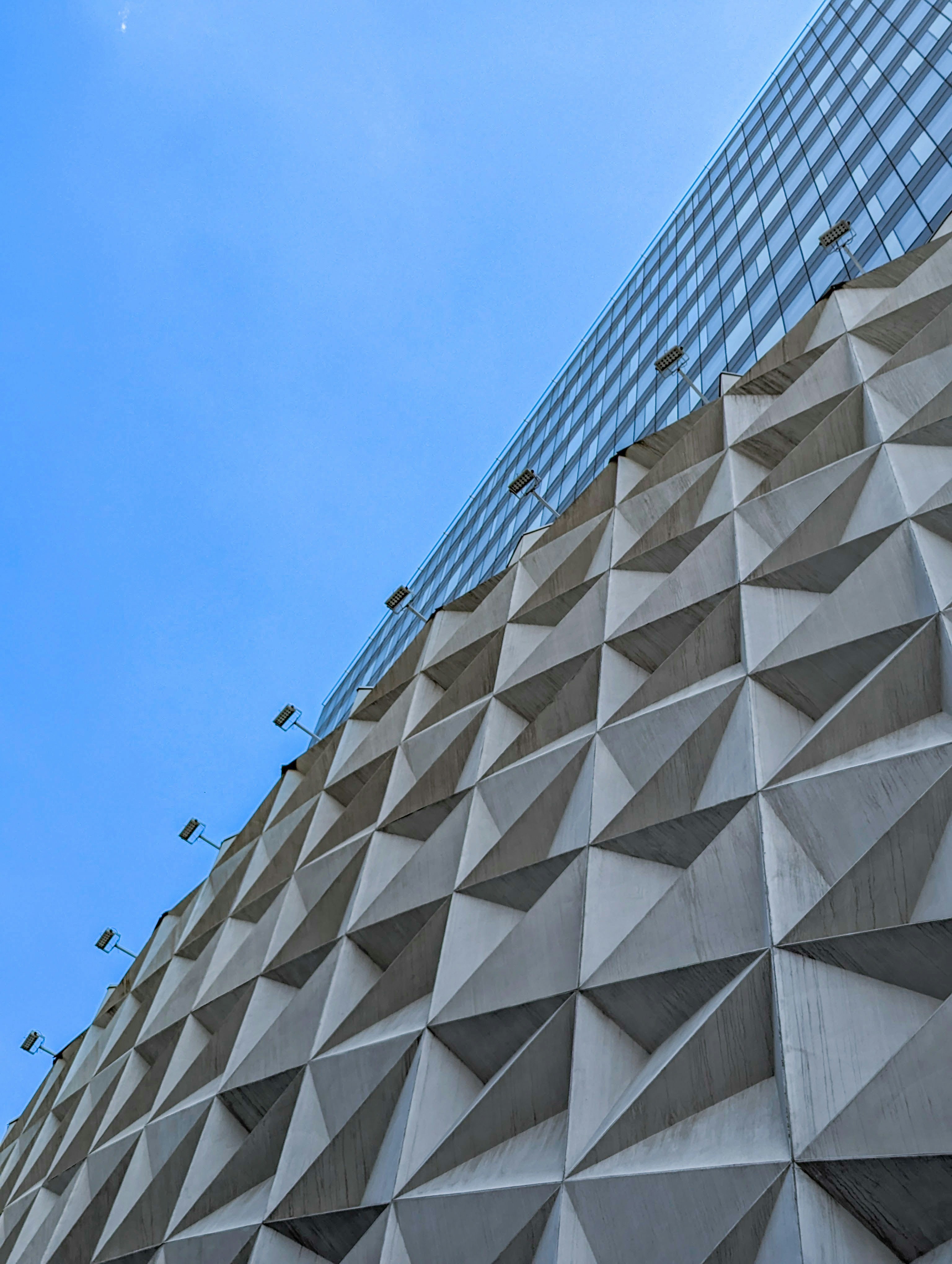 Concrete Triangles Under Blue Sky: A Facade of Repeating Depth