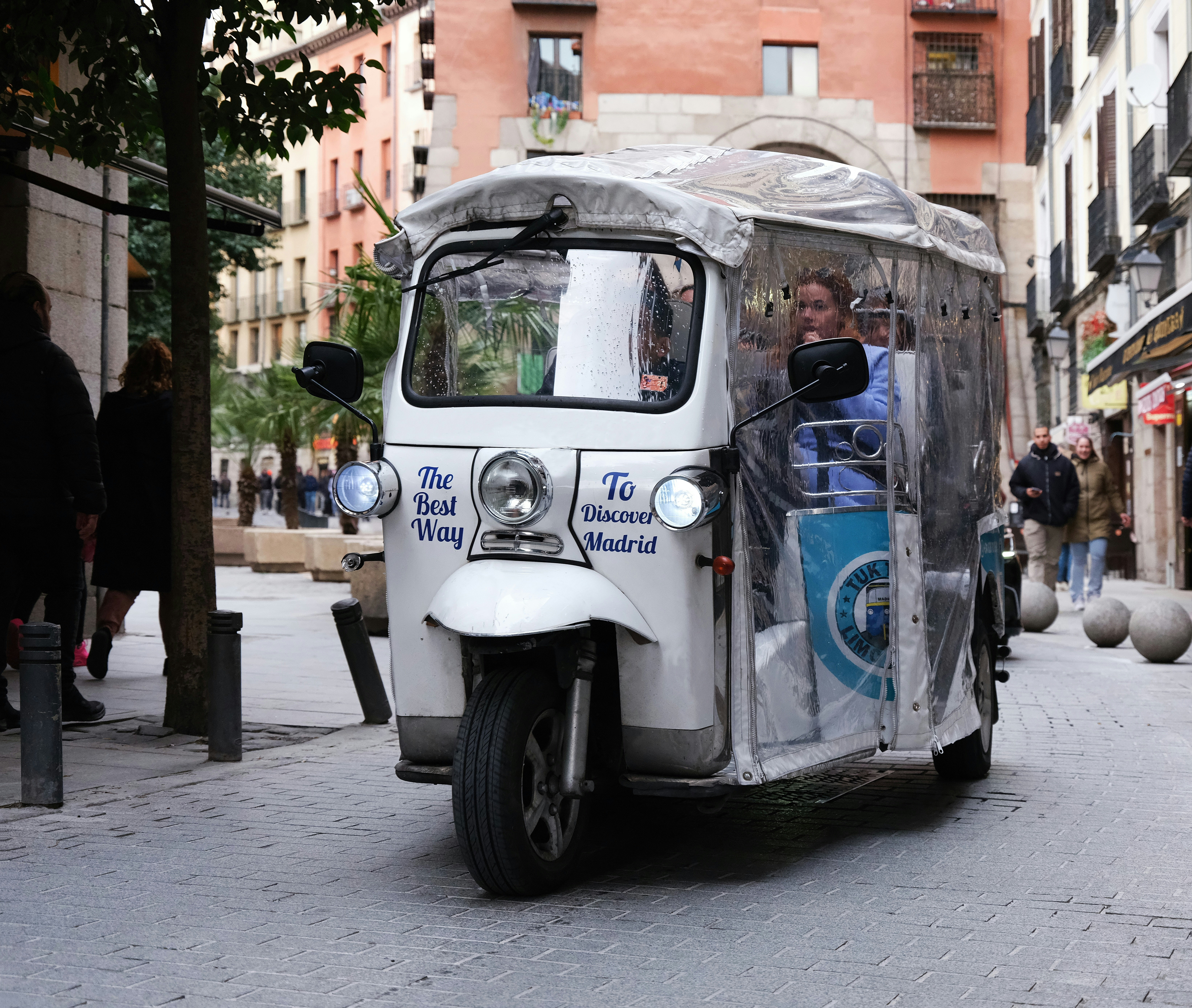 Clear-Canopy Tuk-Tuk Navigates Madrid's Pedestrian Street