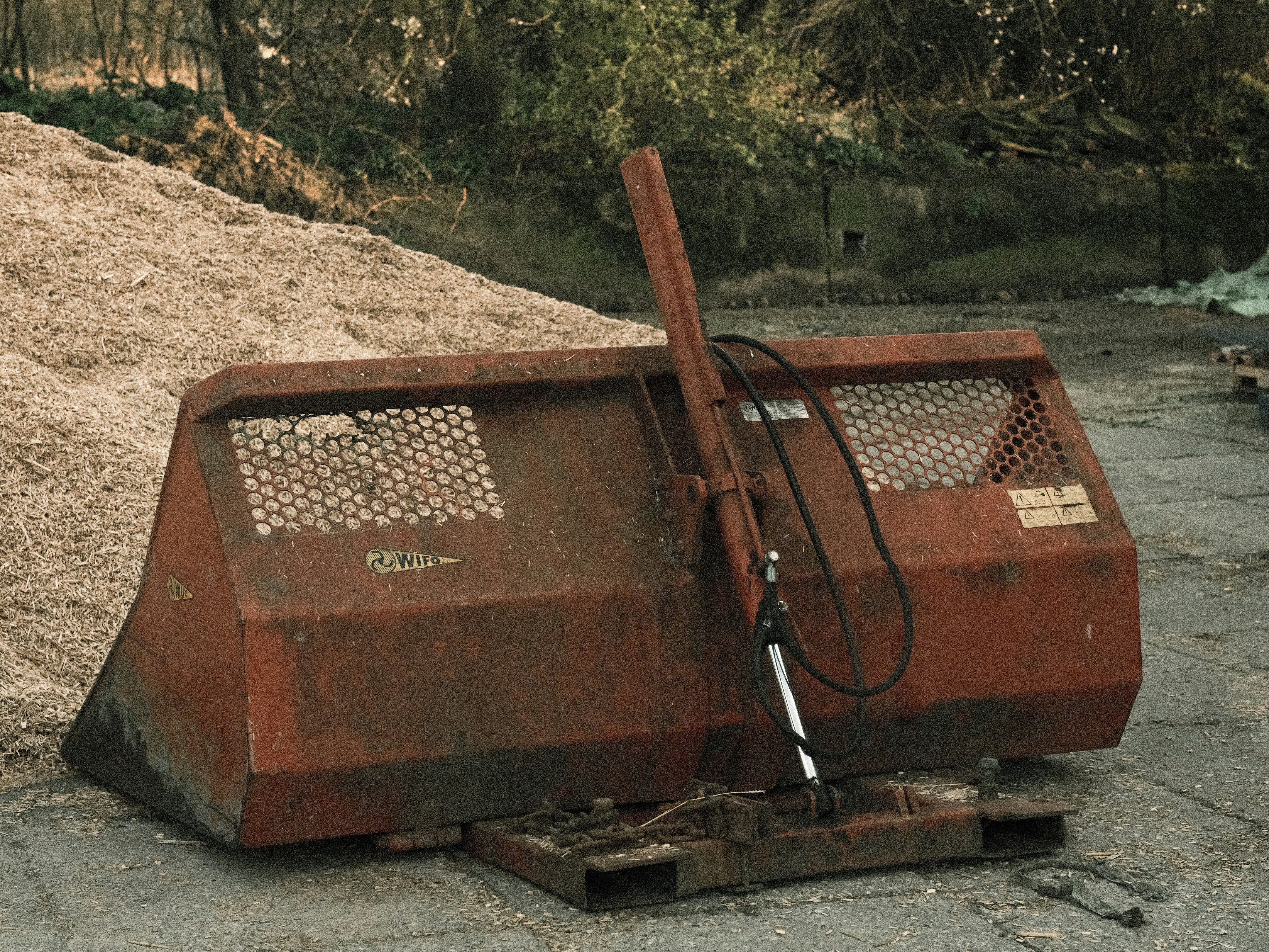 Rust-Crusted Hopper on a Pallet: Weathered Steel on a Gravel Stage