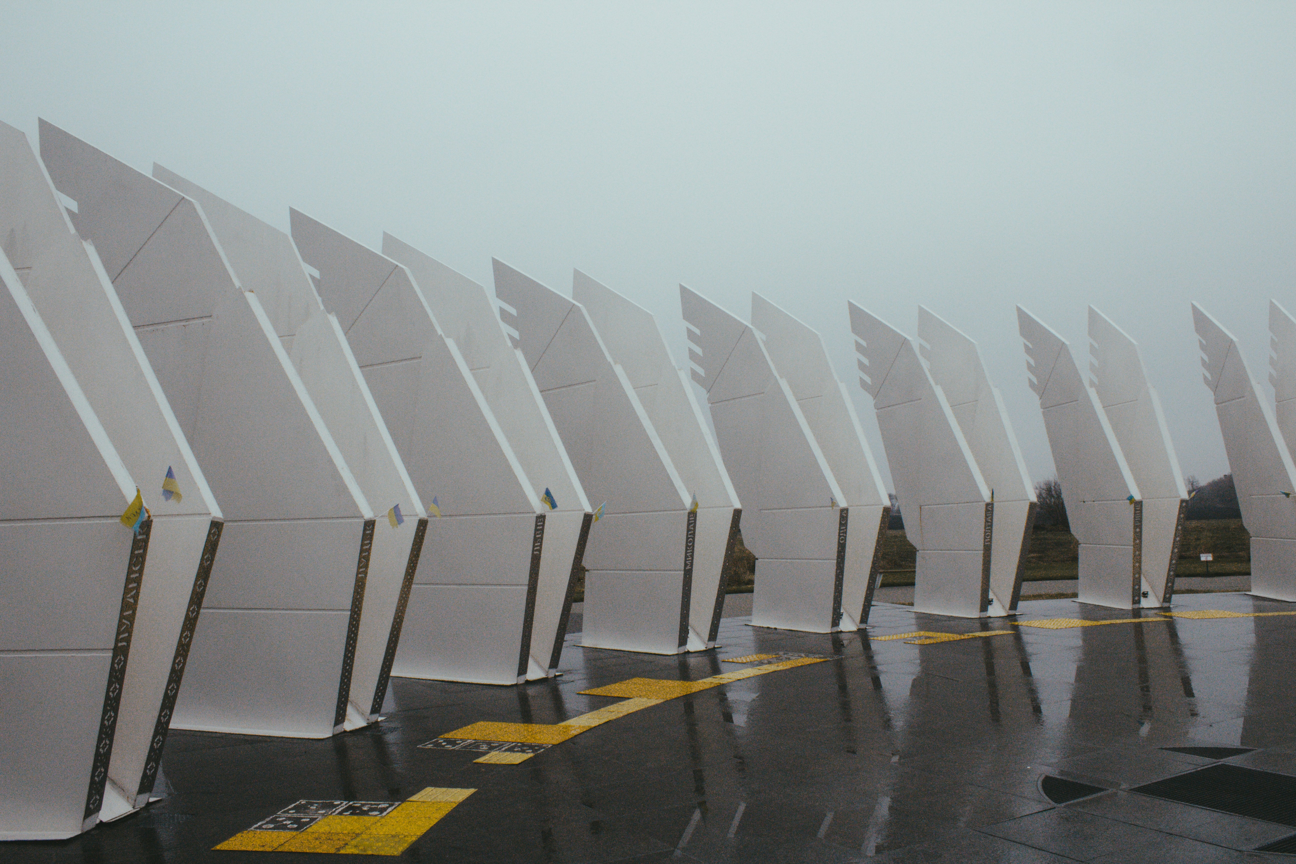 Rows of White Angles: A Rain-Washed Runway Perspective
