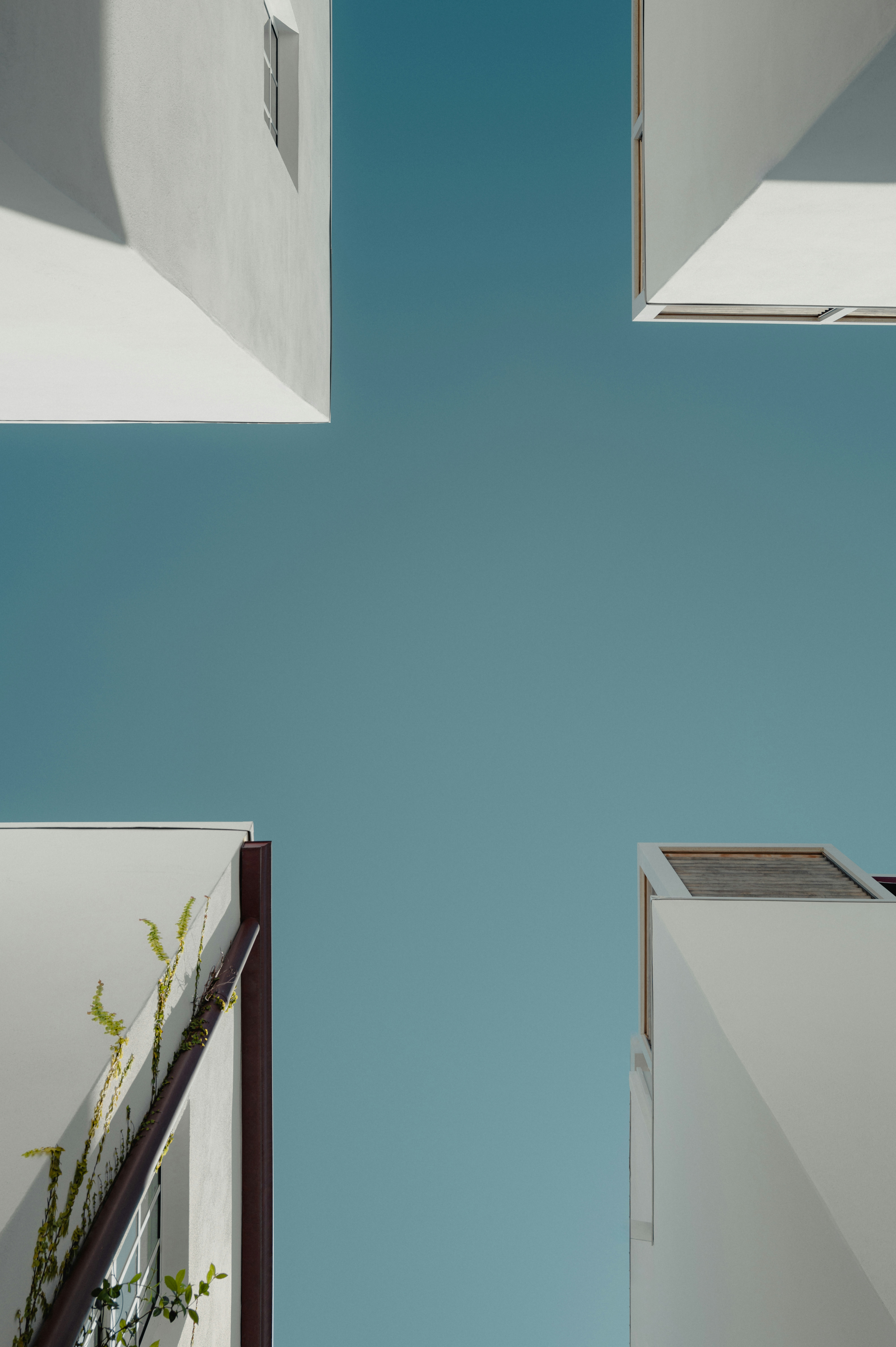 Looking up at the sky from between two buildings photo – Free Miami ...