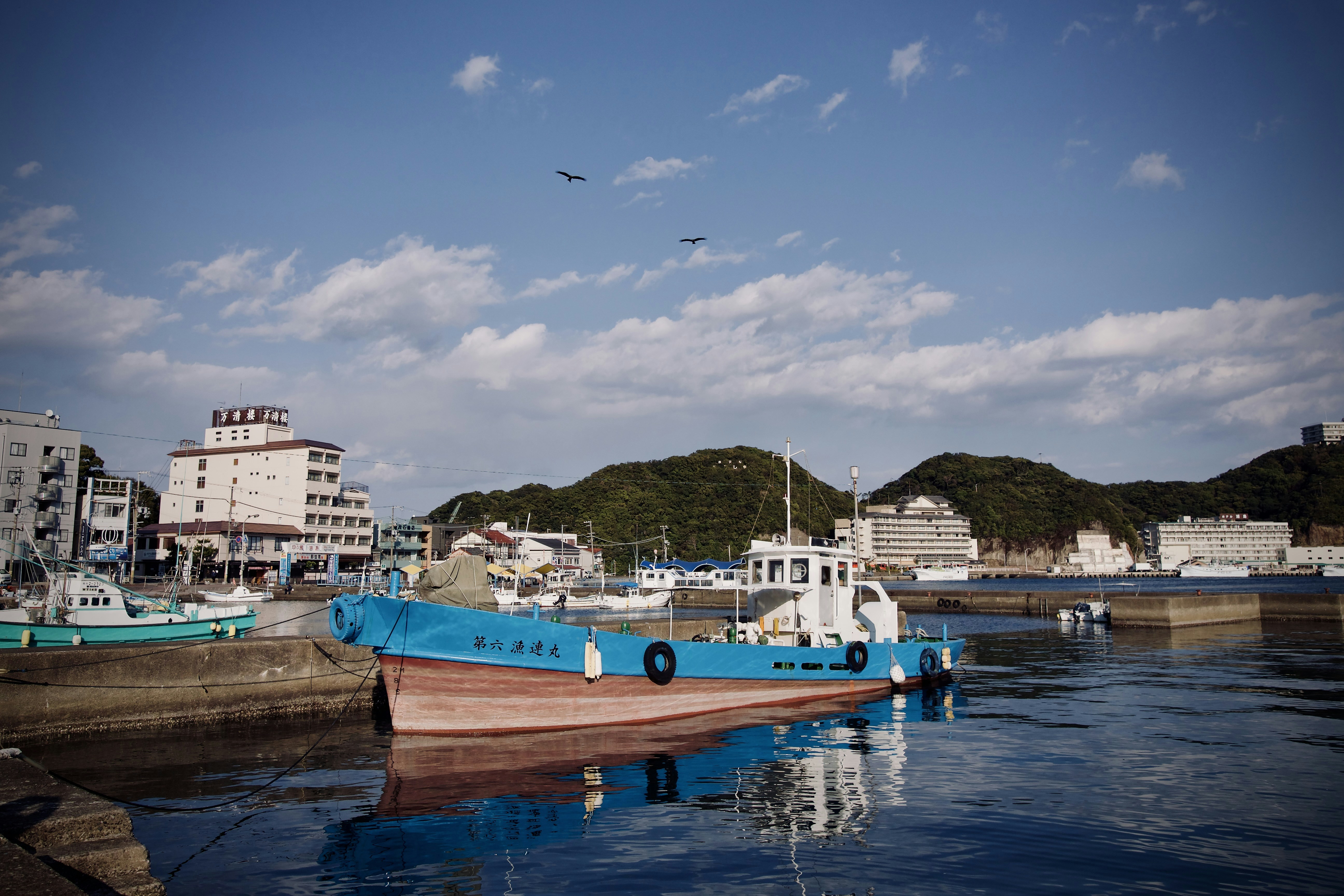 a blue and white boat in the water
