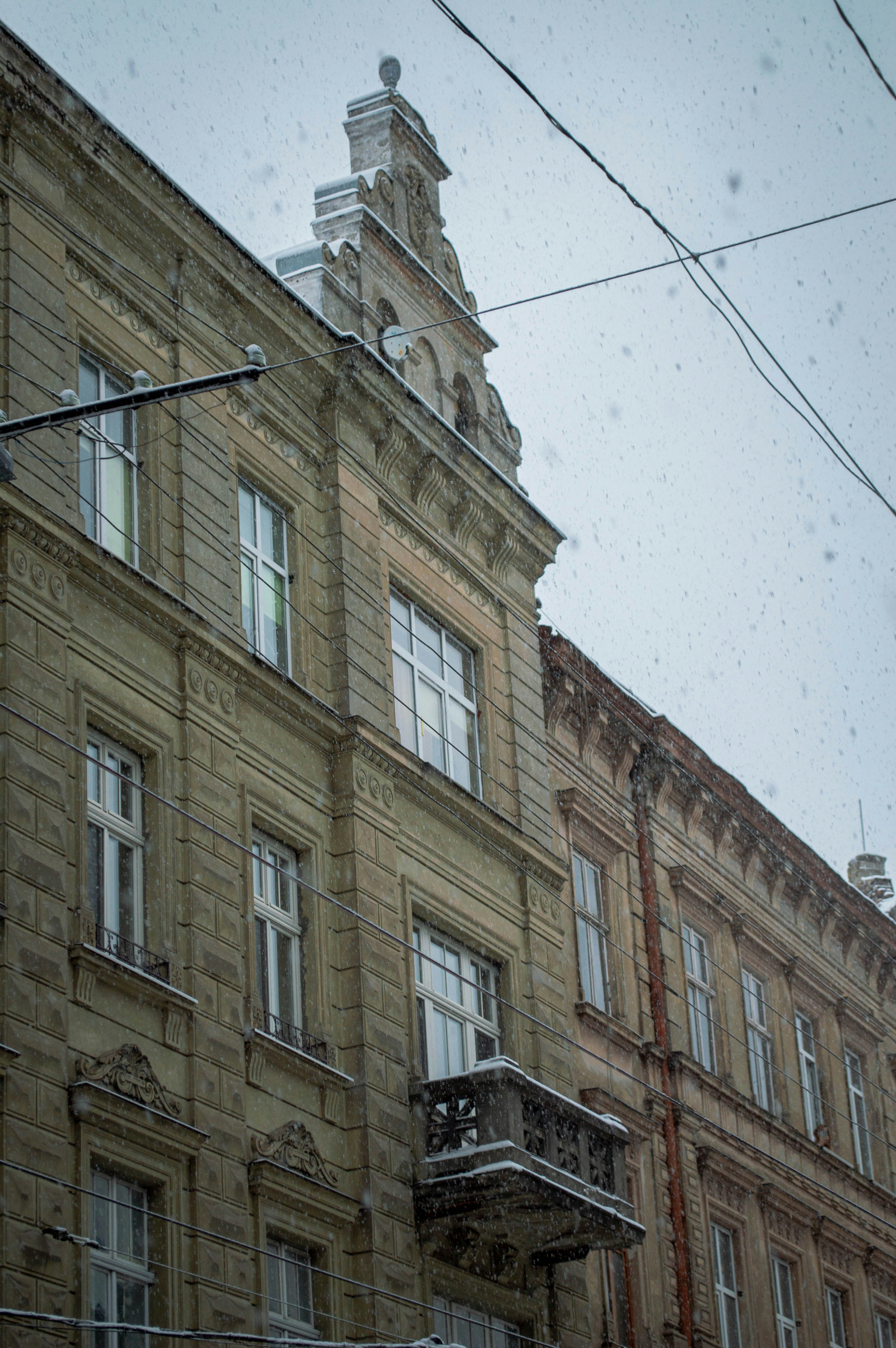 Gilded Gables Under Snowfall: A Historic Street Portrait