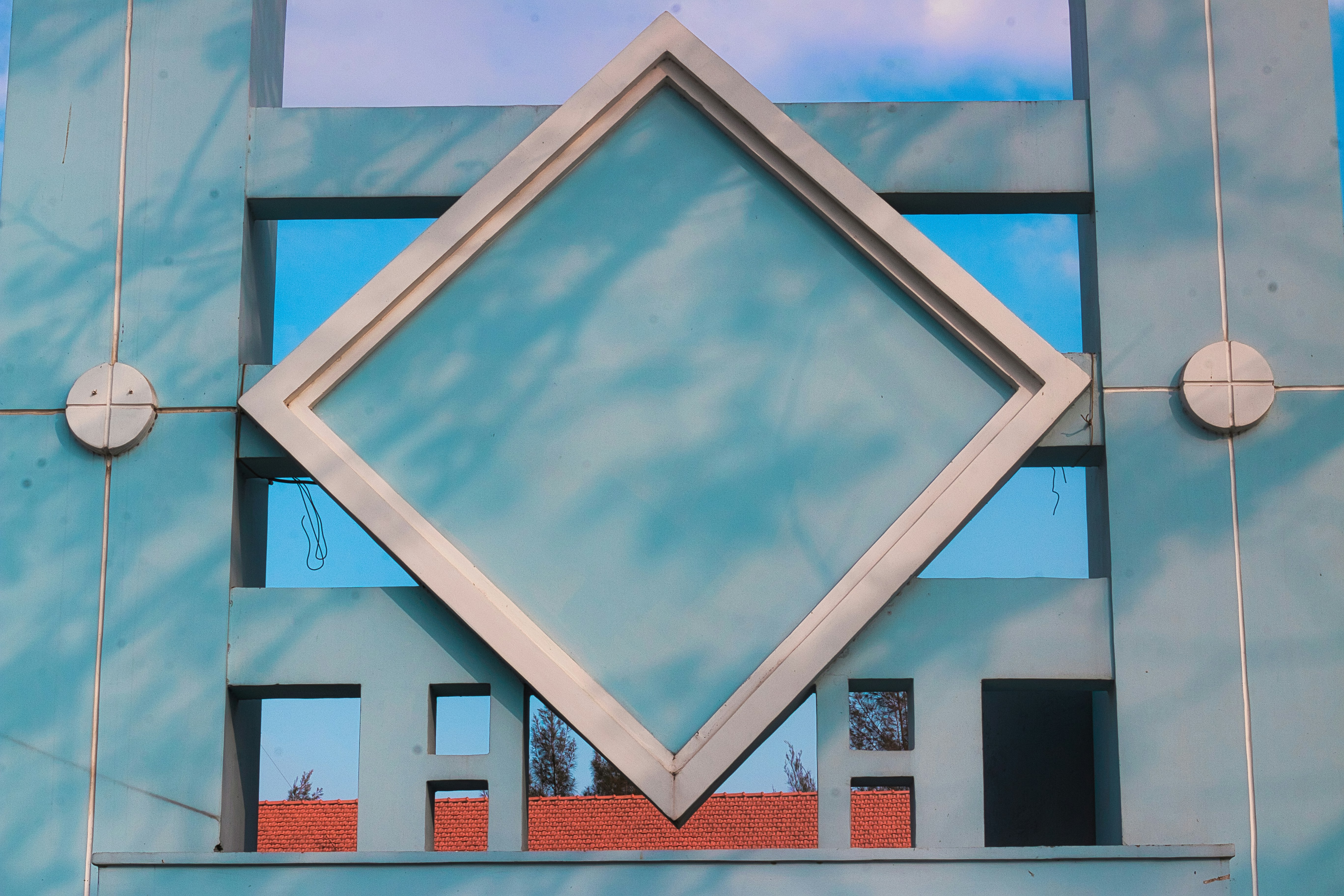 A blue building with a diamond shaped window photo – Free Triangle ...
