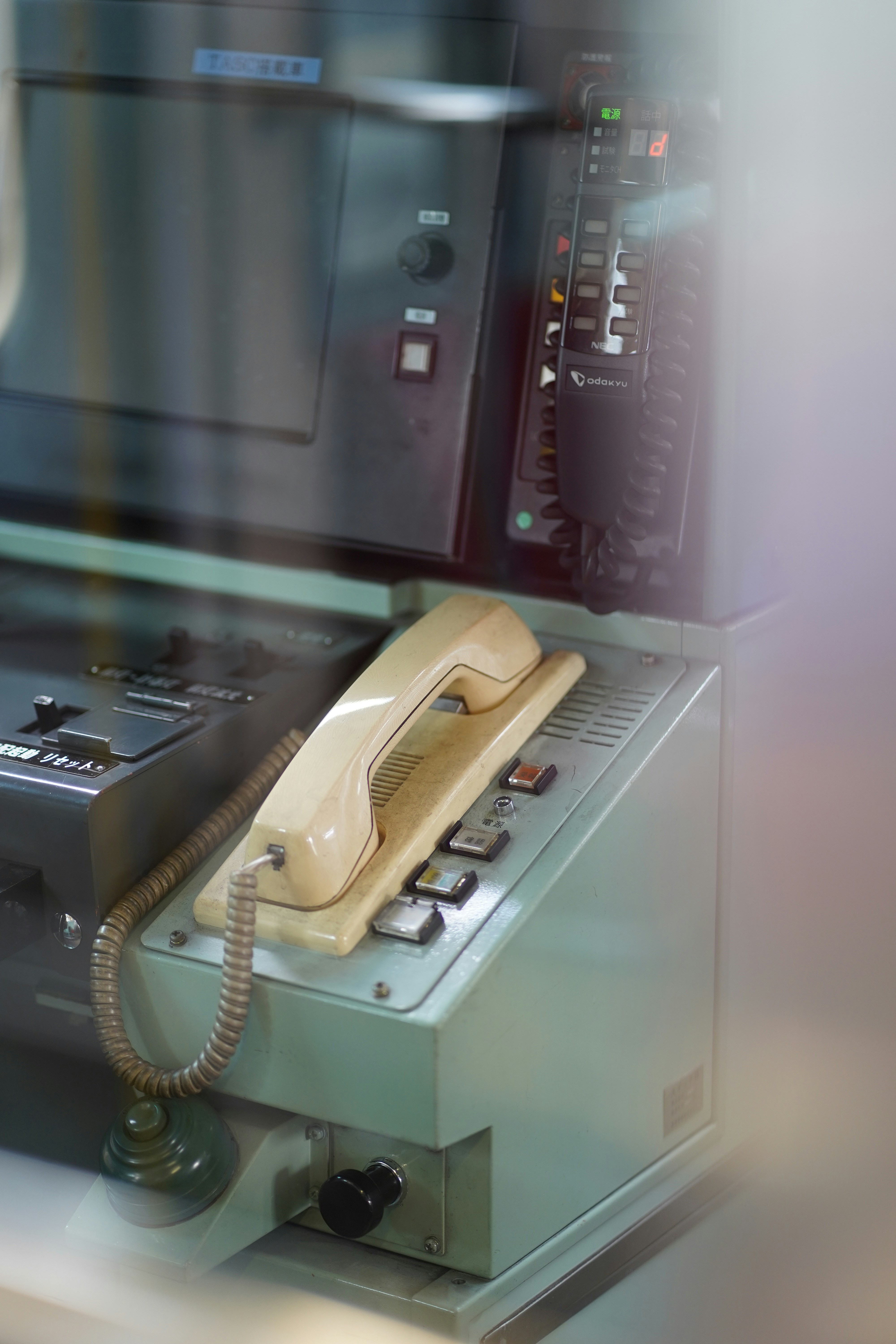 Close-up of an old-fashioned telephone and control panel, showcasing retro technology in a modern setting.