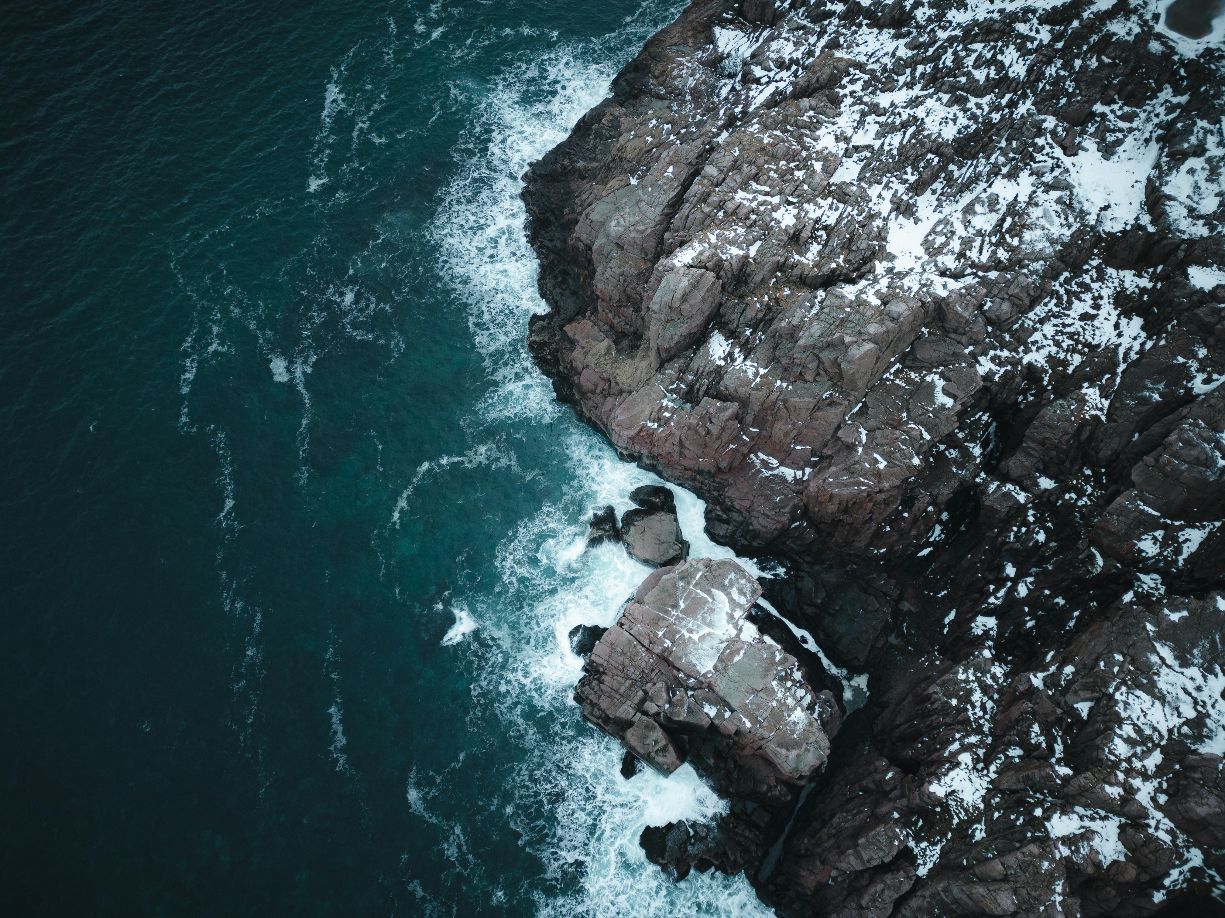 A large body of water surrounded by rocks photo – Free Teriberka Image ...