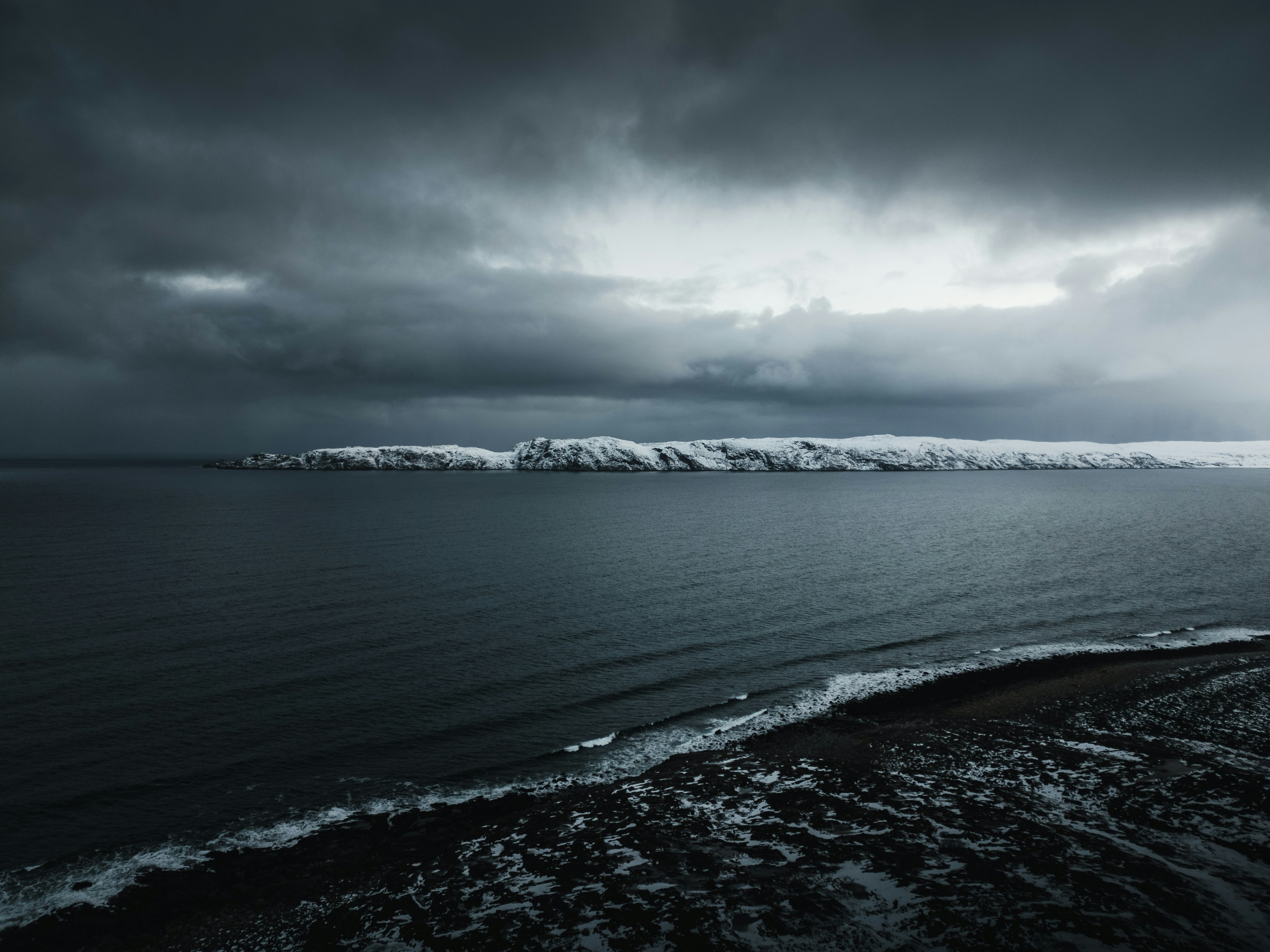 A large body of water under a cloudy sky photo – Free Russia Image on ...