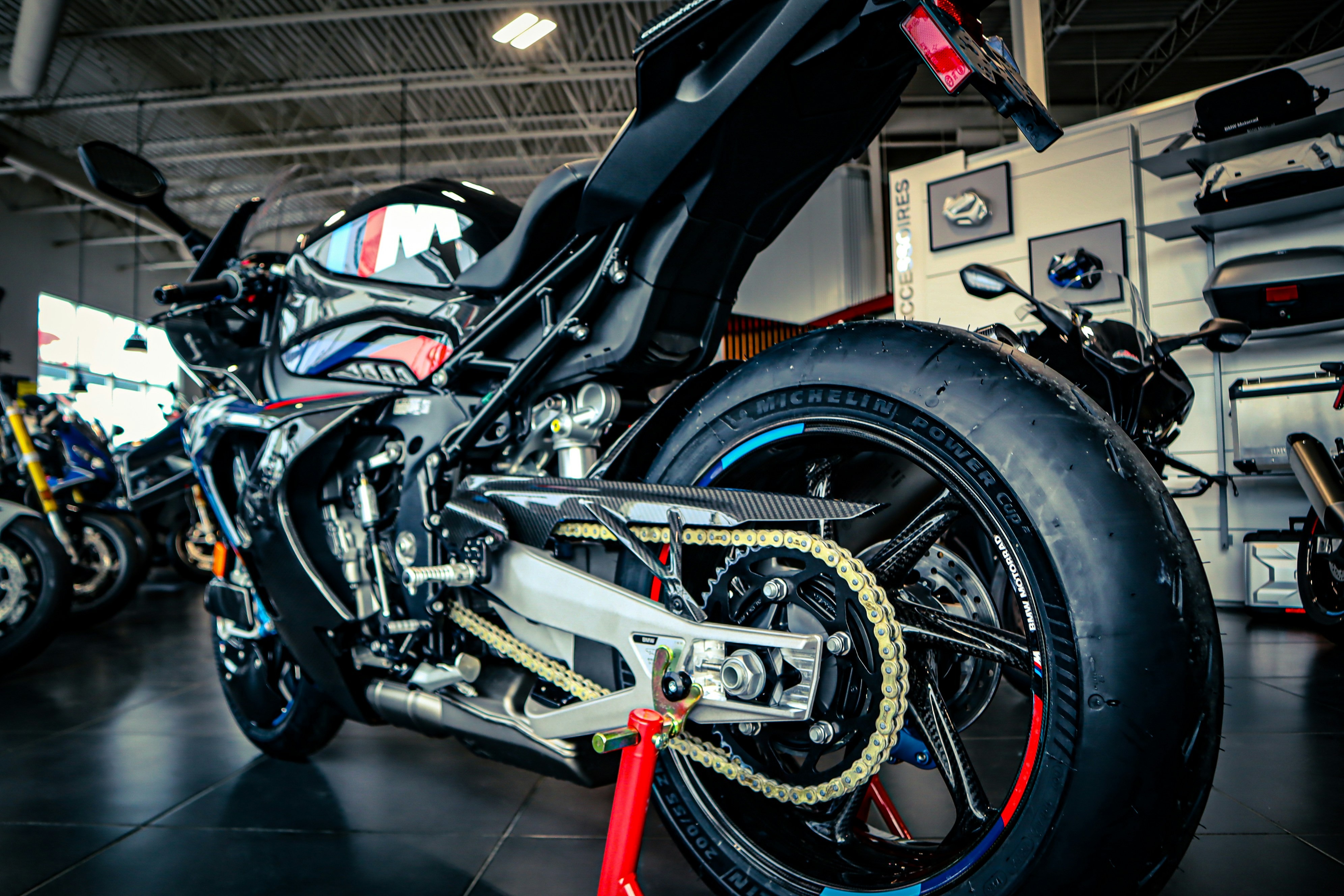 A motorcycle parked inside of a garage next to other motorcycles photo ...