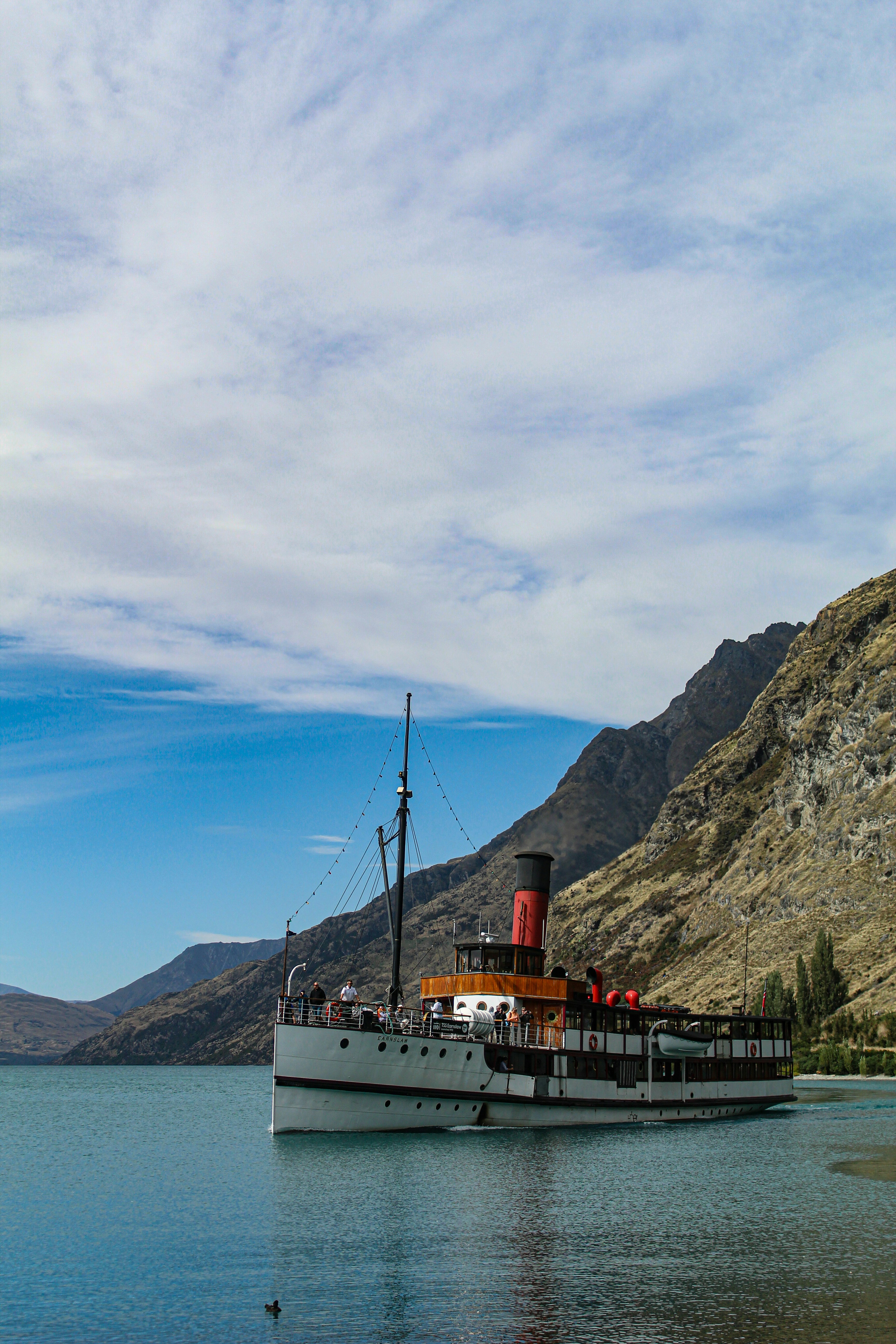 A large boat floating on top of a large body of water photo – Free ...