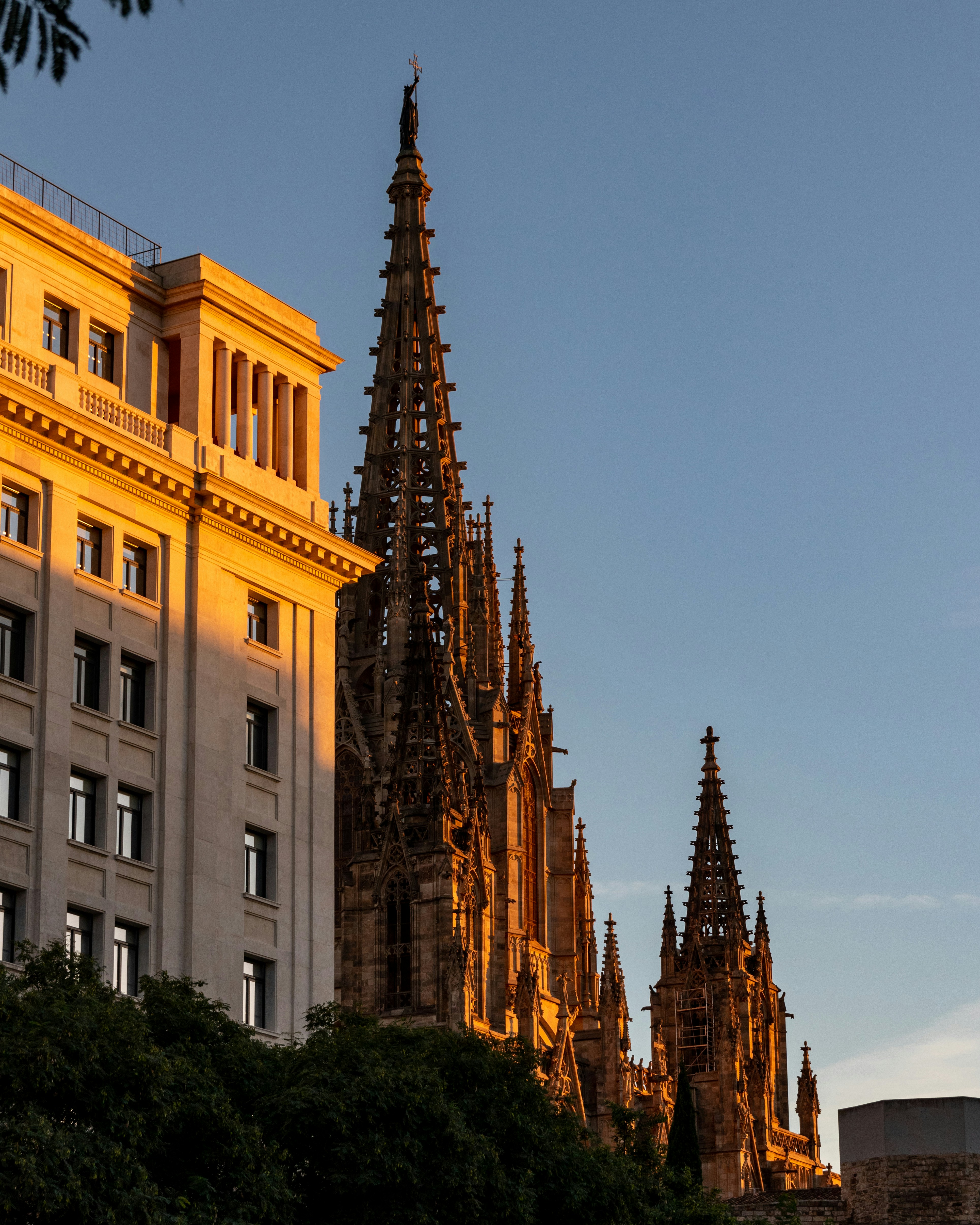 Sunlit Gothic Spires Over a City Facade at Golden Hour
