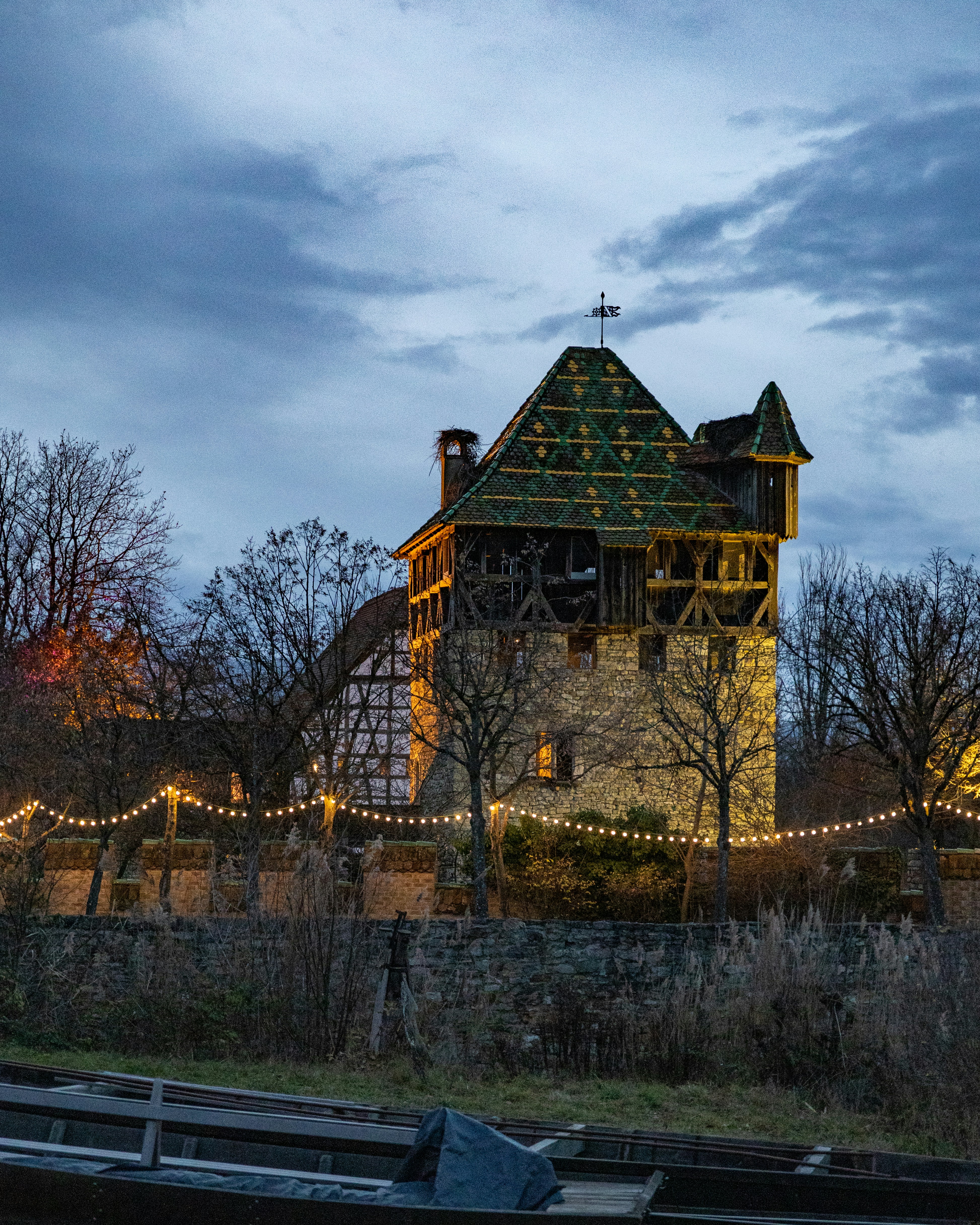 Dusk-Lit Ruin: Warm Lights Embrace a Timber Watchtower