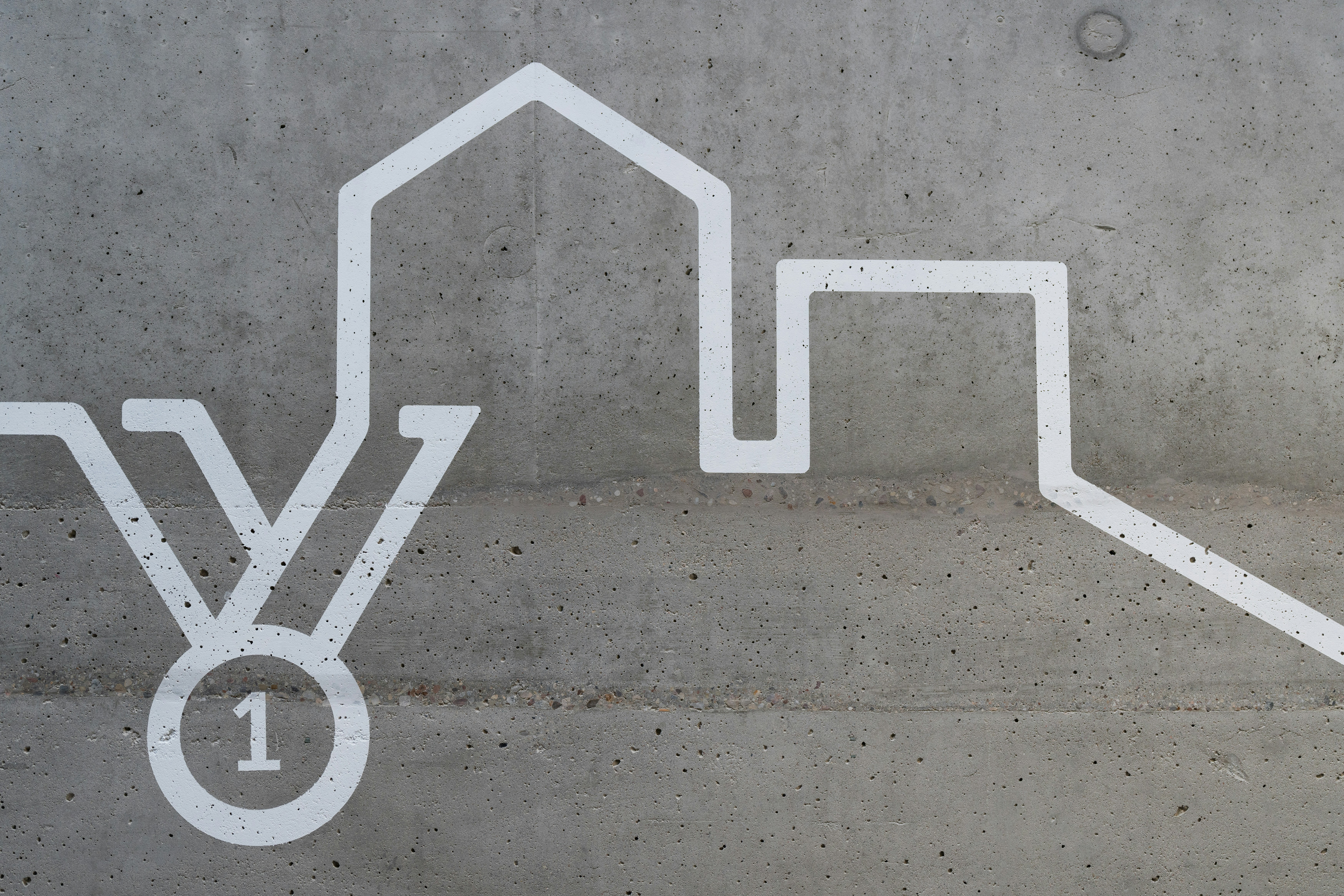 Grounded Geometry: A solitary '1' anchors a white cityscape on concrete