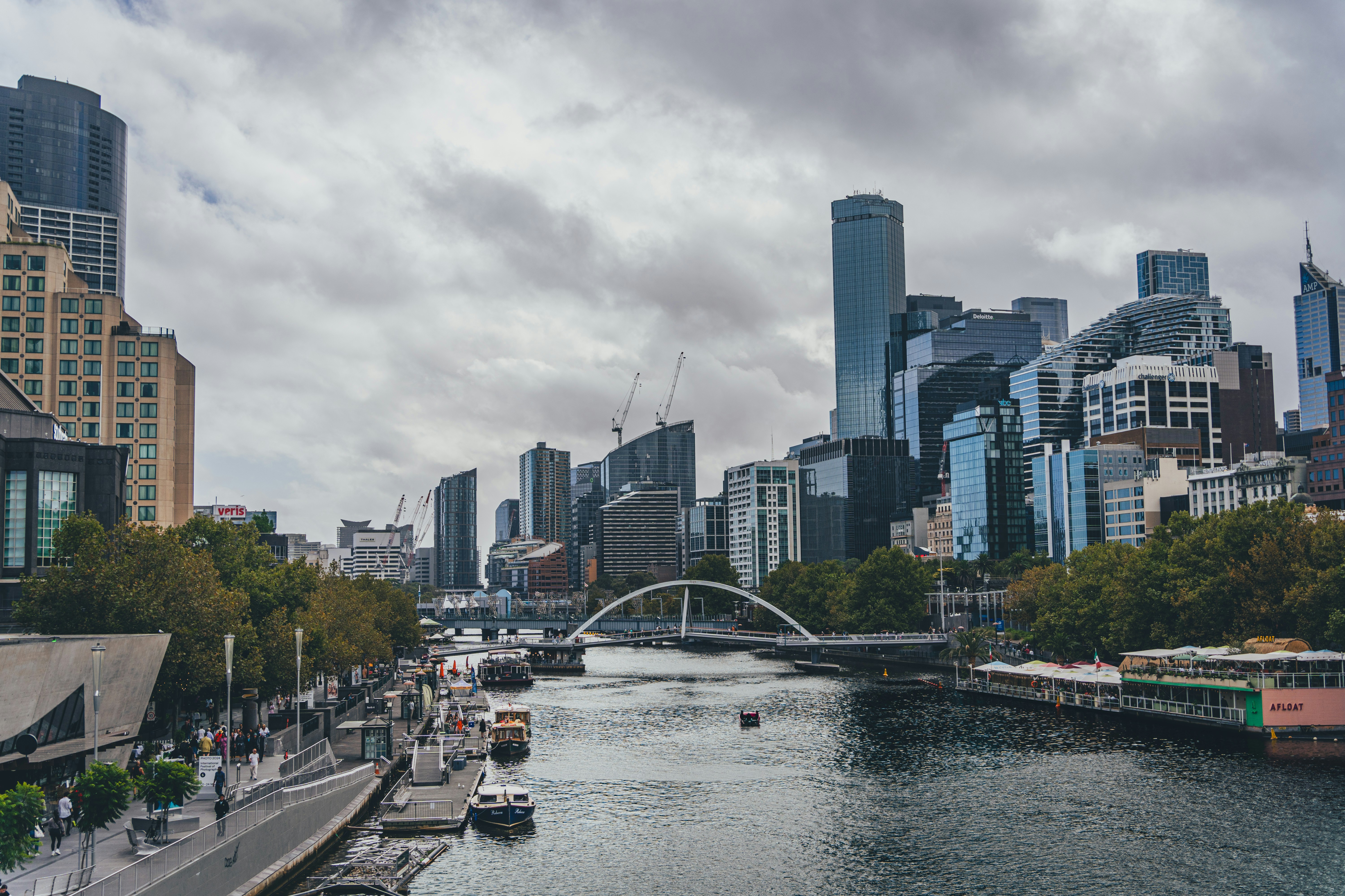 A river running through a city next to tall buildings photo – Free ...