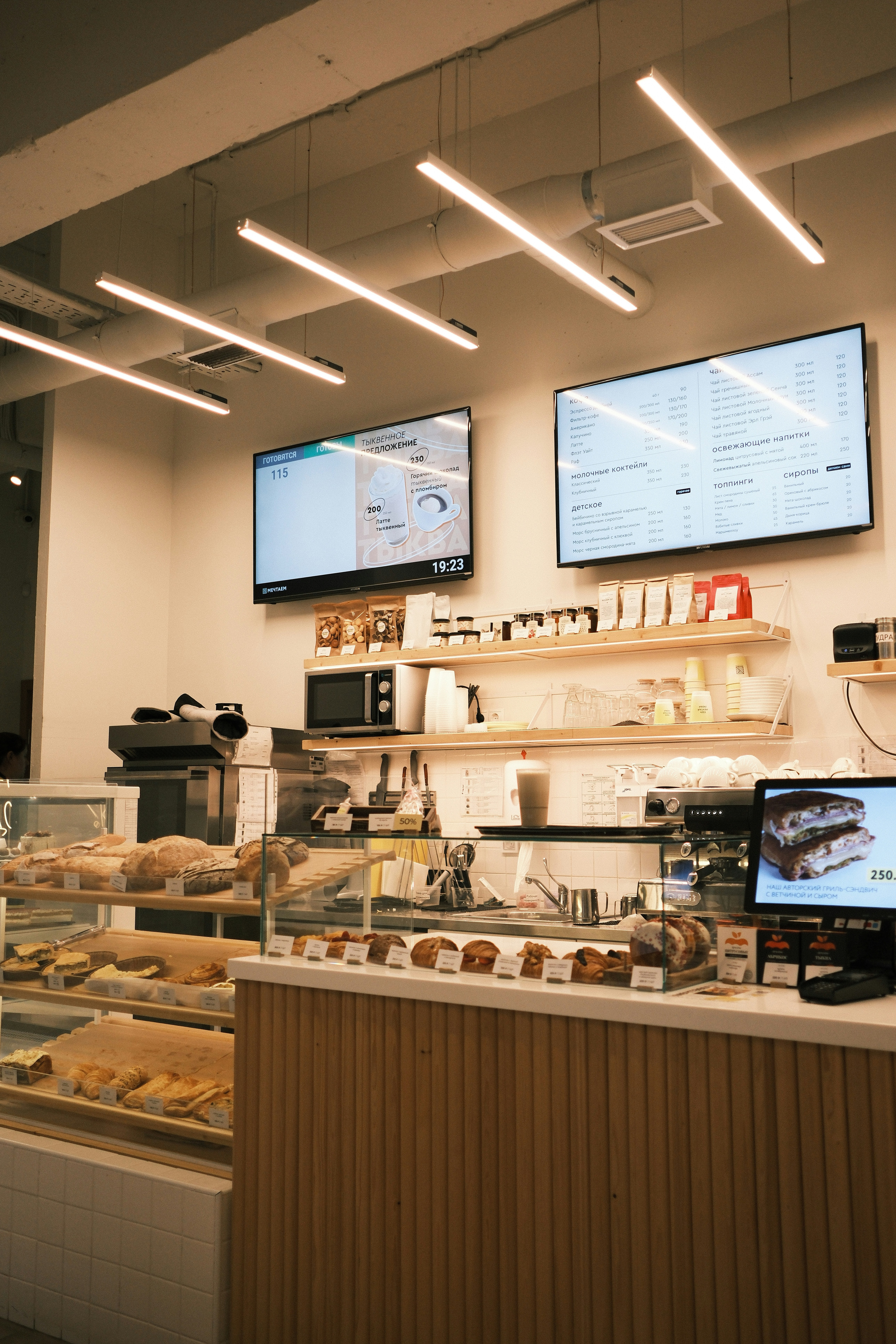 Warm Glass and Pastry Light: A Quiet Moment at the Café Counter