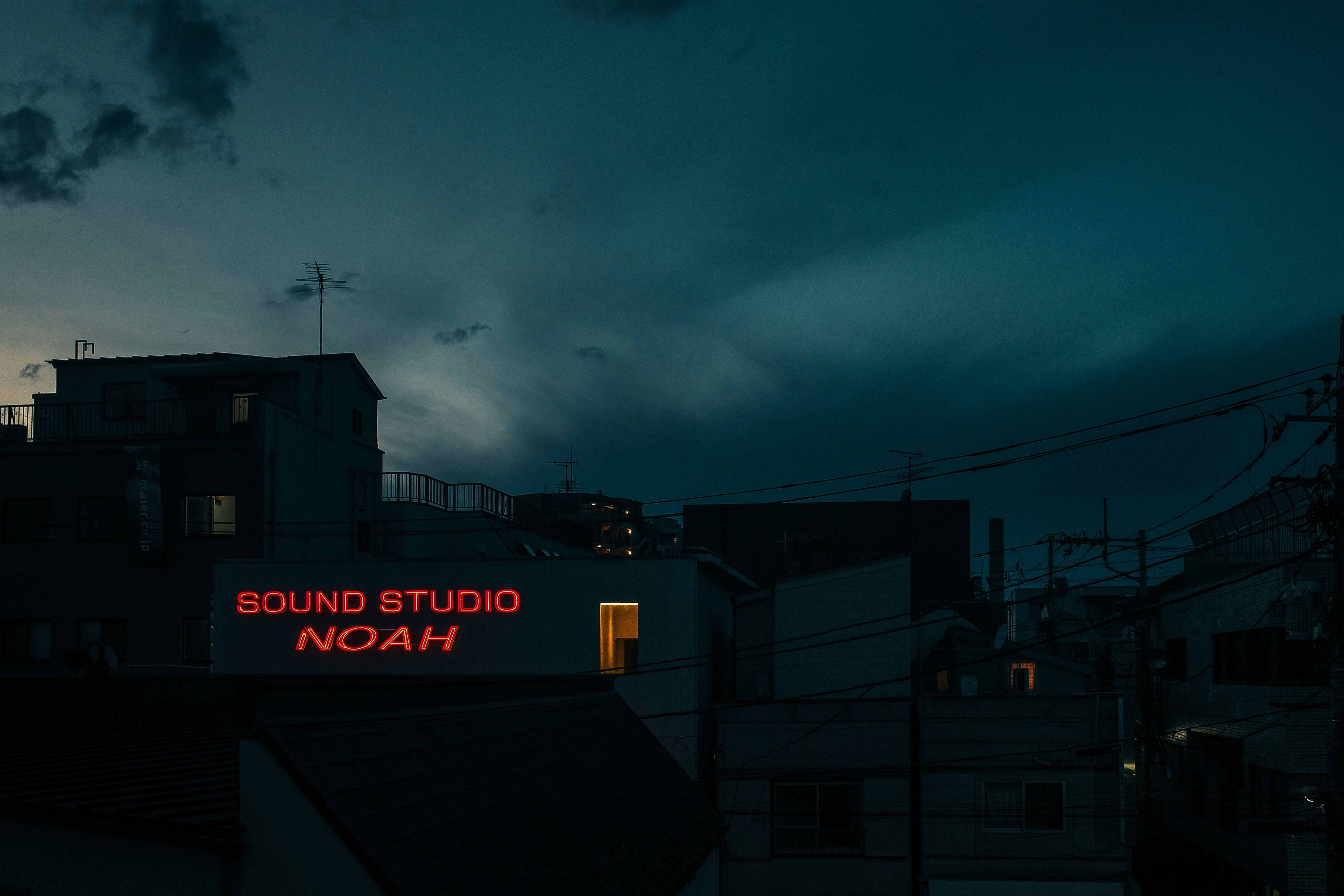 A building with a neon sign that reads sound studio noah photo – Free ...