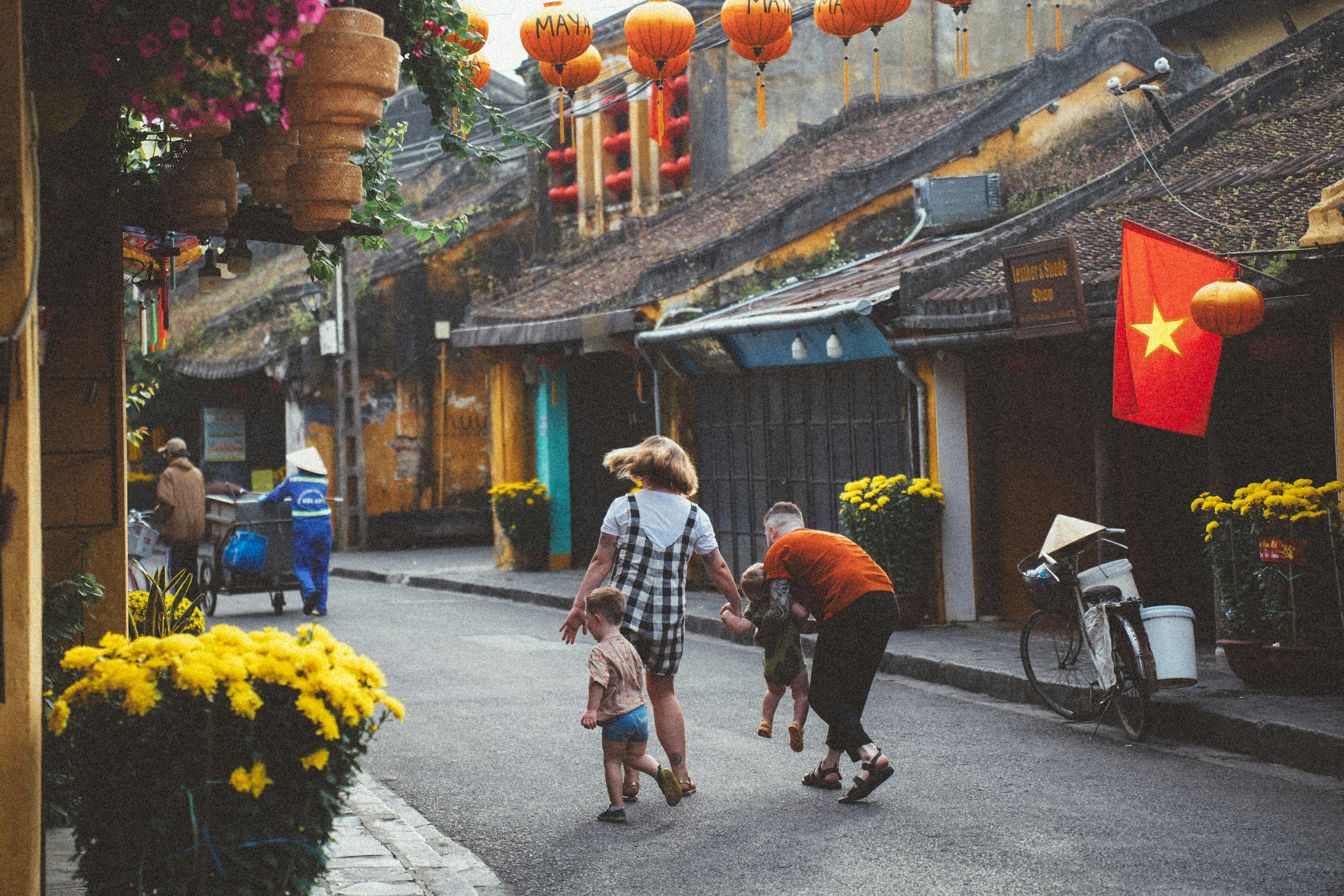 A group of people riding skateboards down a street photo – Free City ...