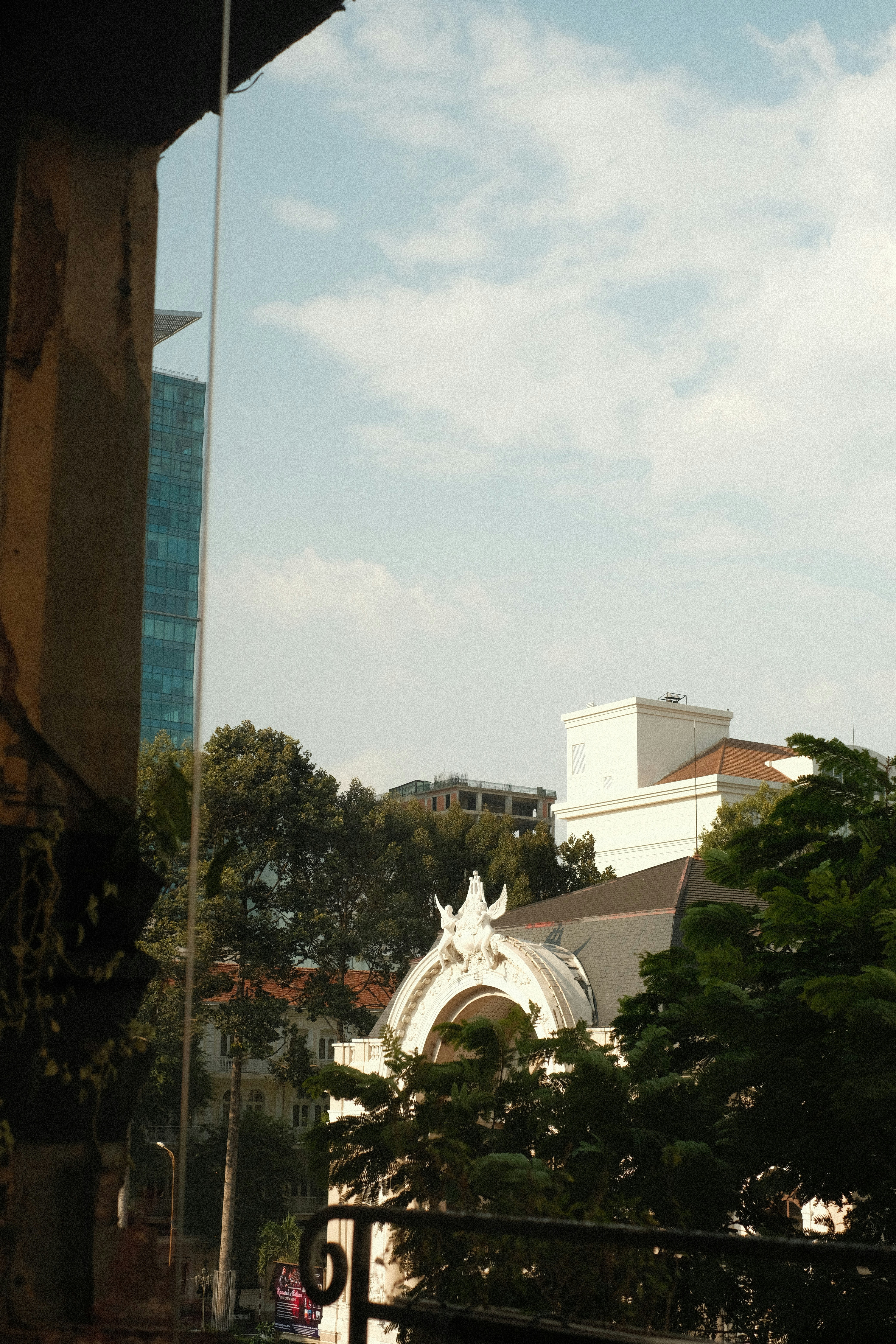Arched Crest Peeking Through City Foliage
