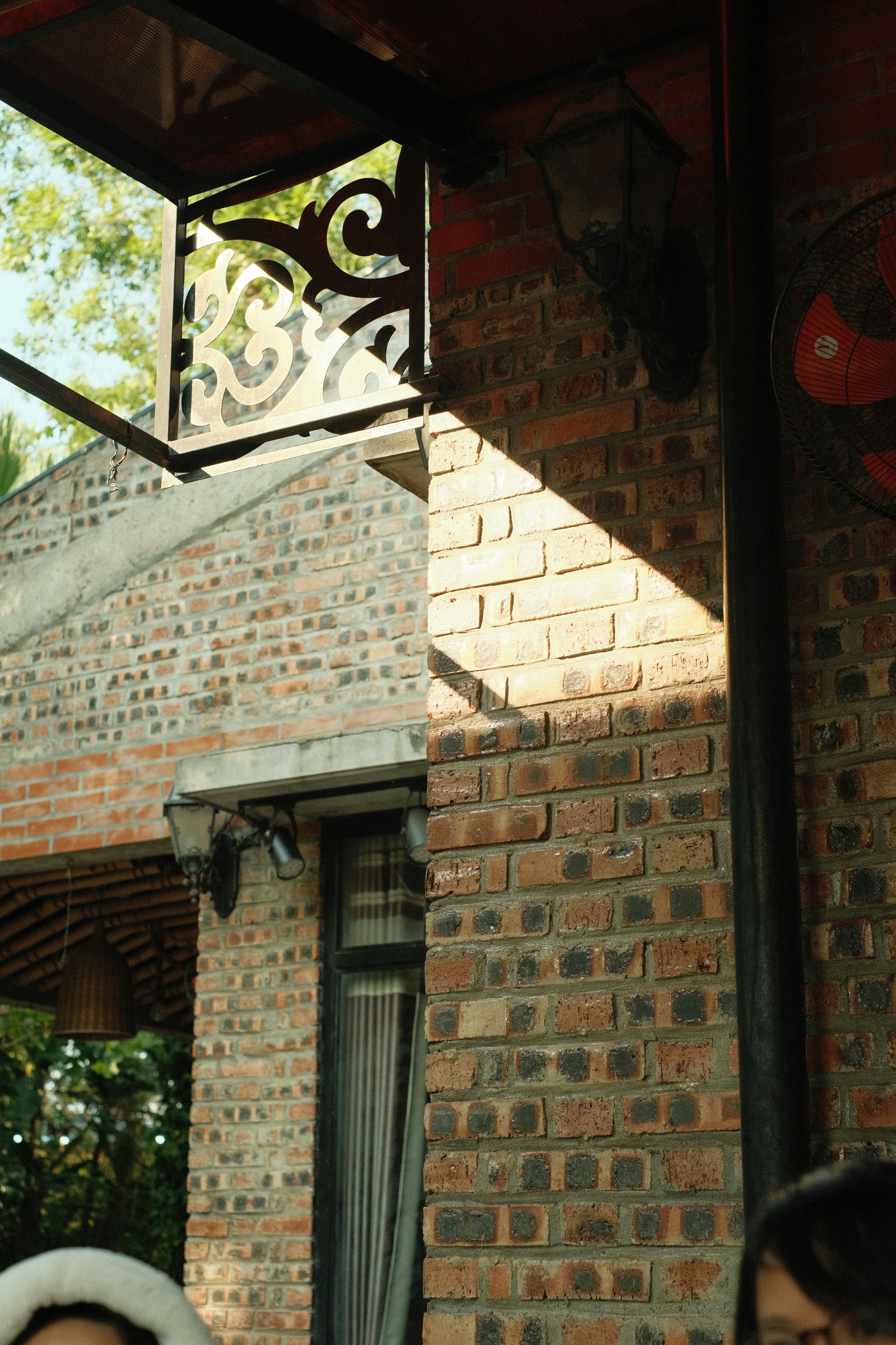 Sunlit Brick Arch and Shadowed Porch