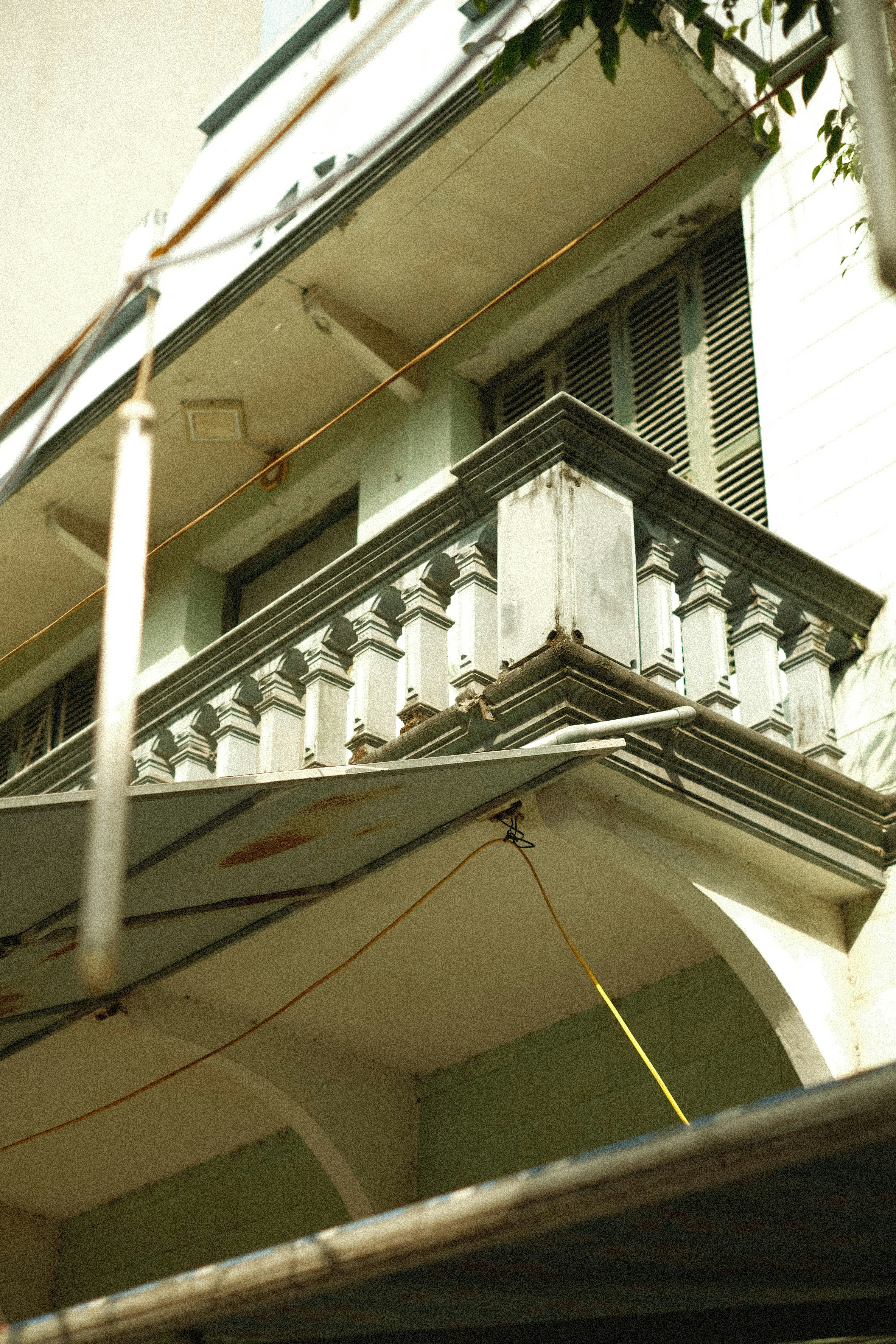 Edge of Quiet Geometry: Weathered Balustrade and Arched Porch