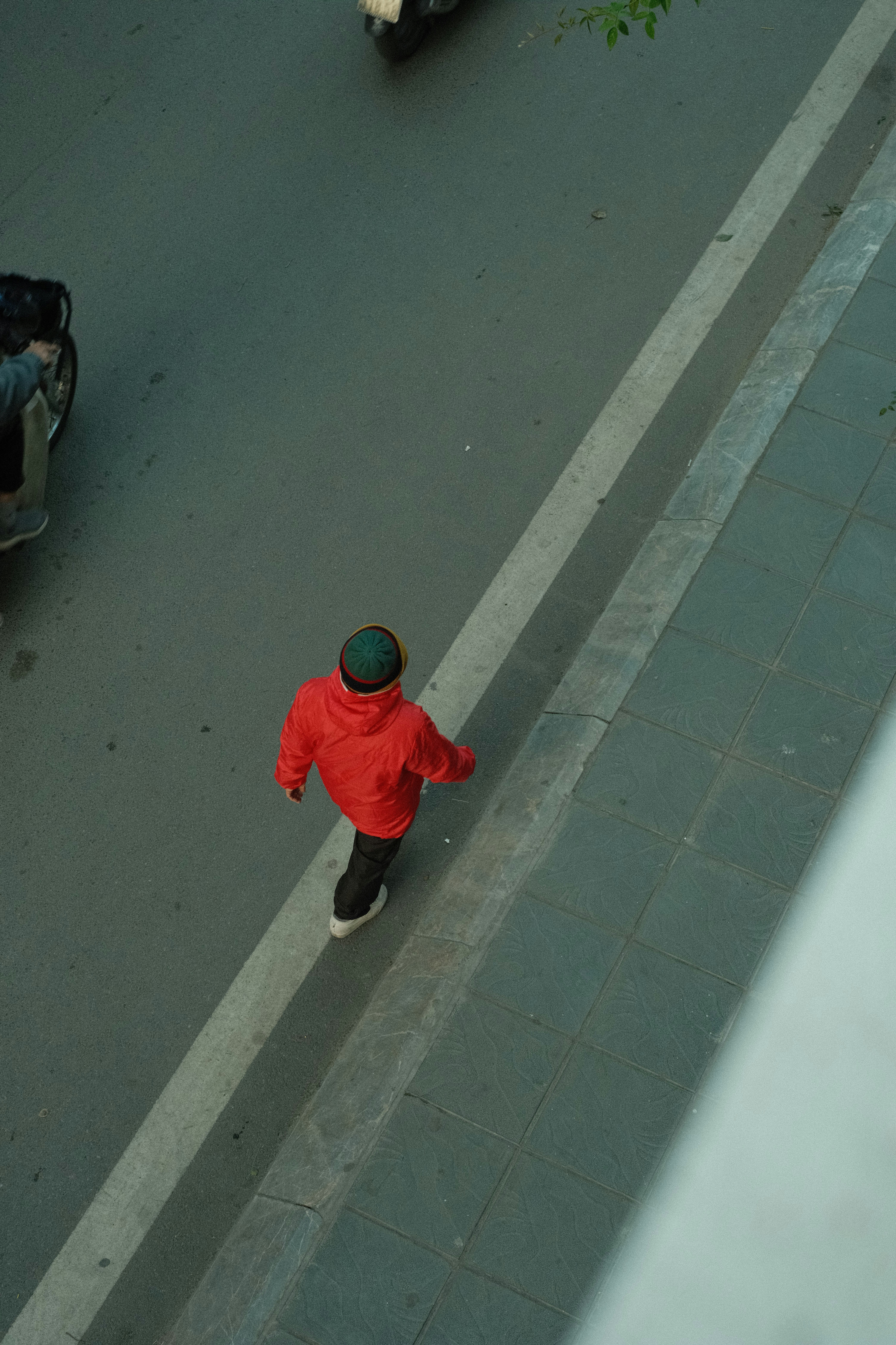 Red Jacket on the Diagonal: A Solo Stride Along the City Edge