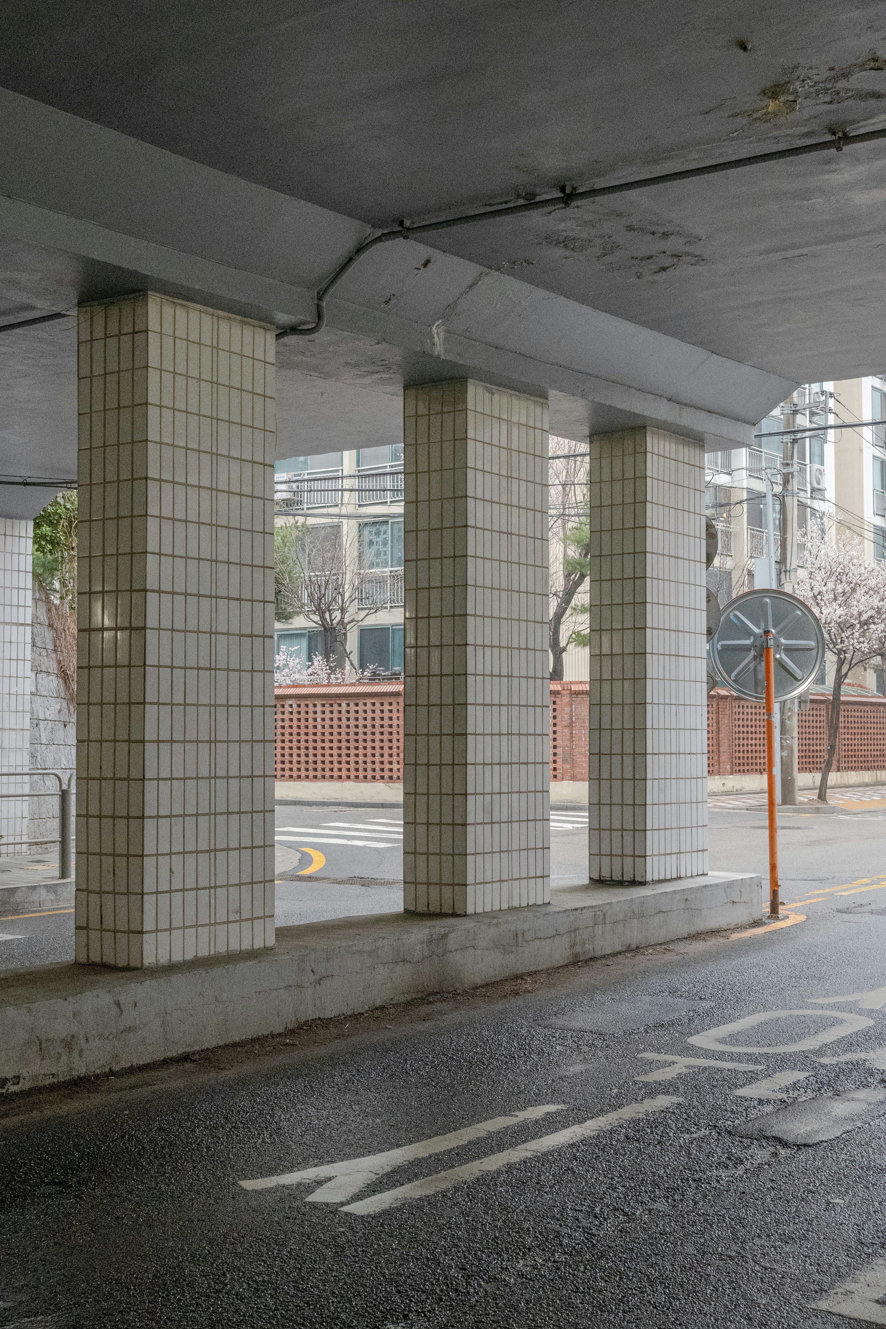 An empty parking garage with columns and a stop sign photo – Free City ...