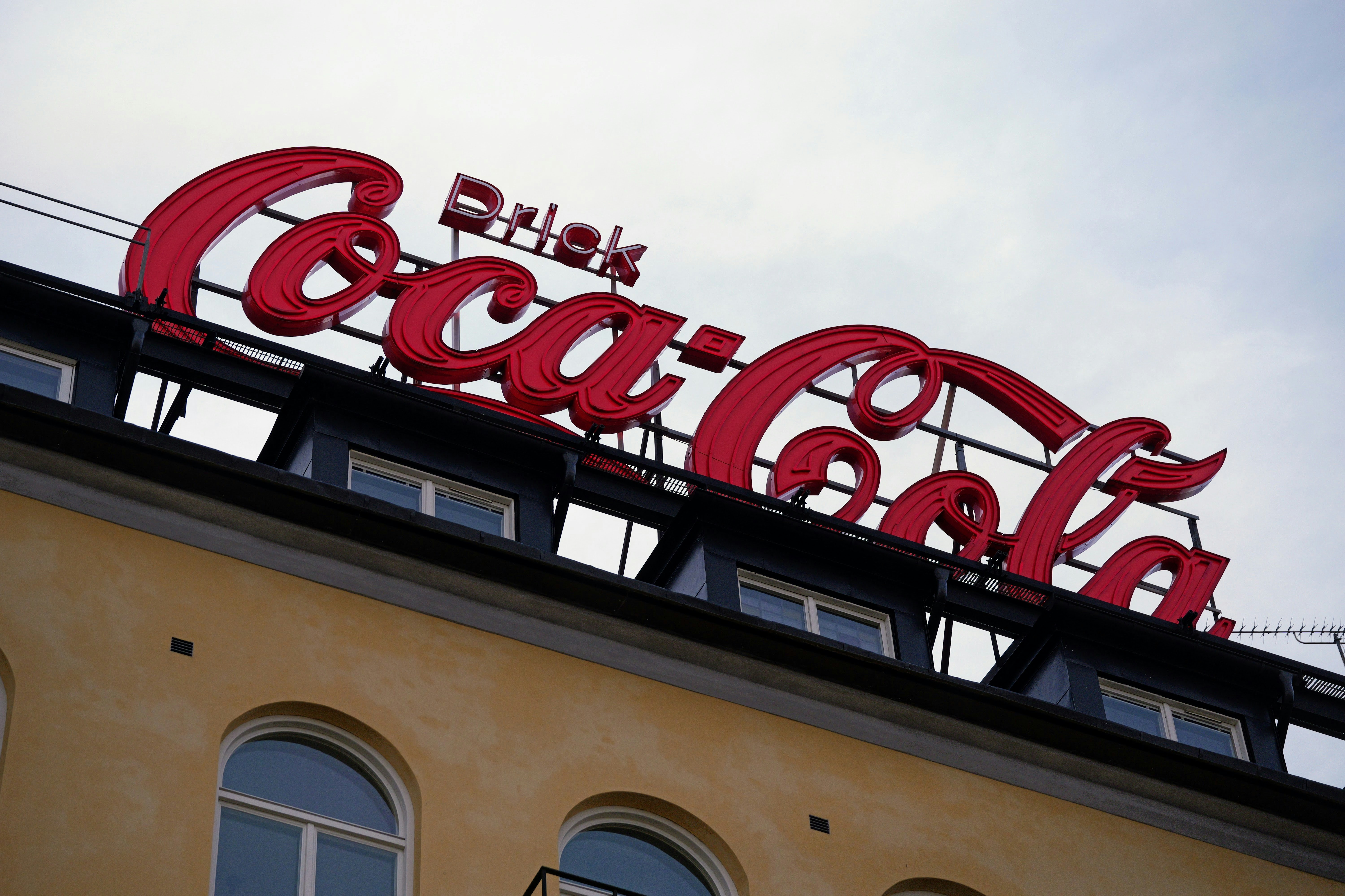 A large coca cola sign on top of a building photo – Free Outdoor Image ...
