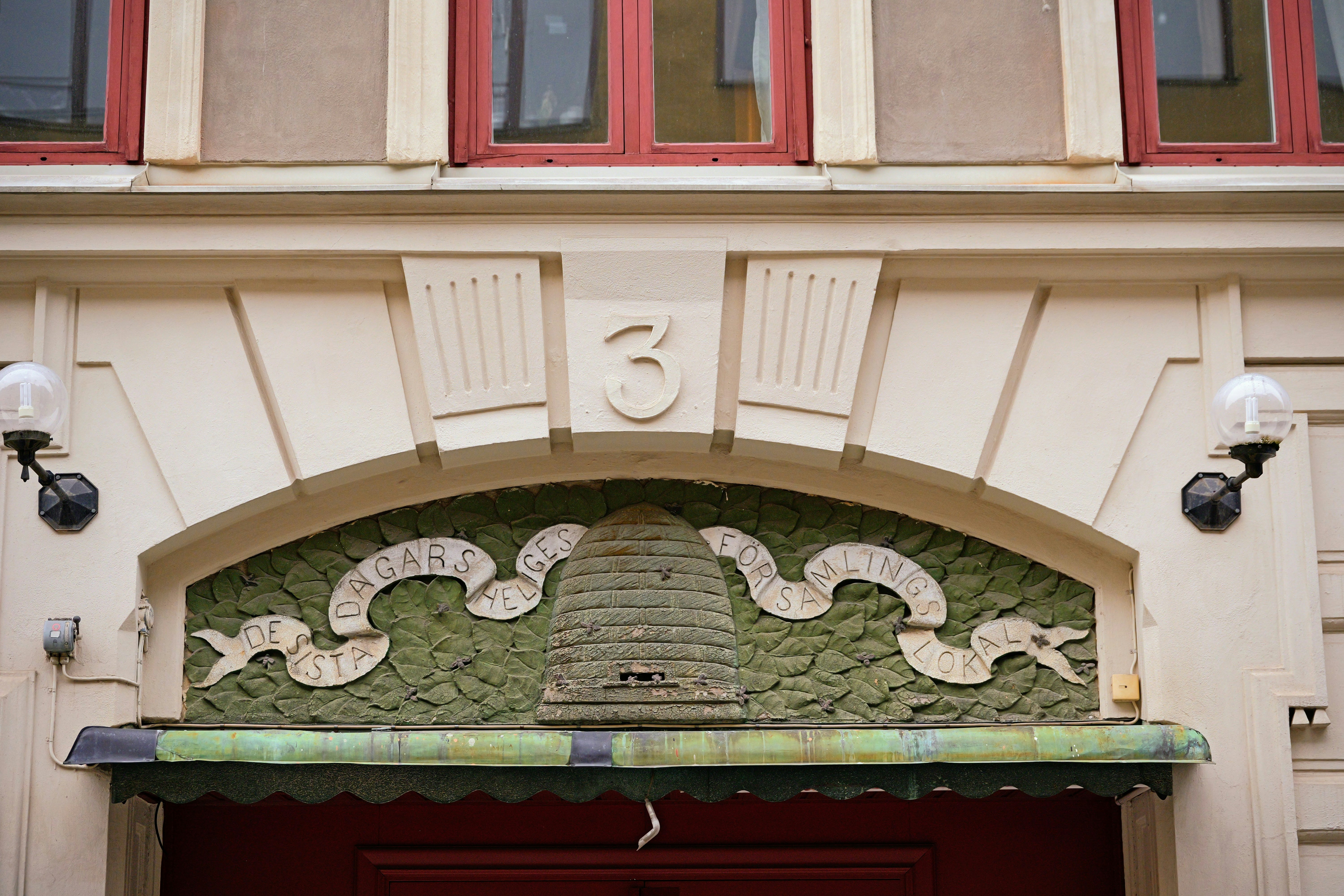 Architectural Crest: Beamed Archway Above a Historic Door