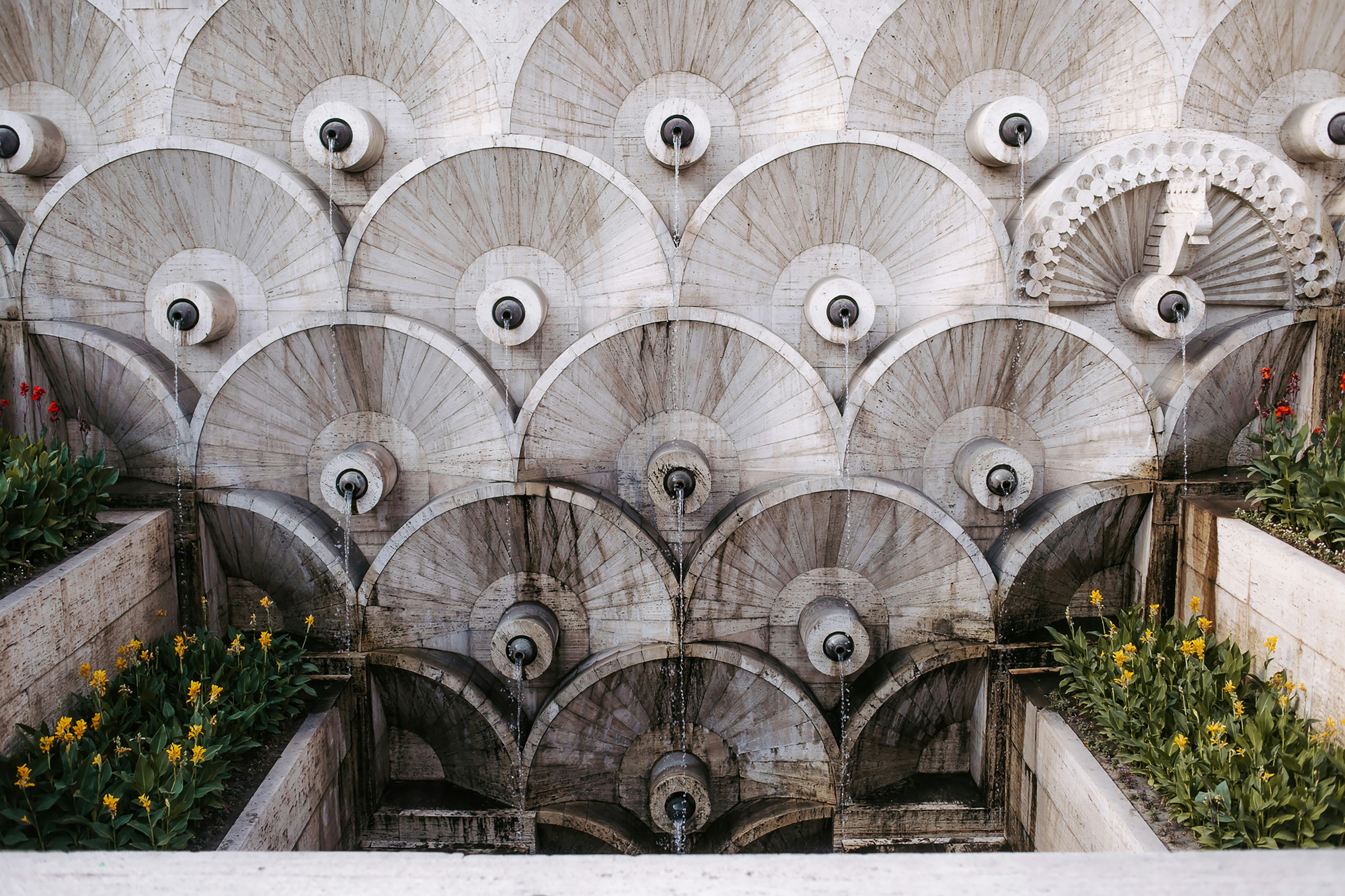 A group of water fountains sitting next to each other photo – Free ...