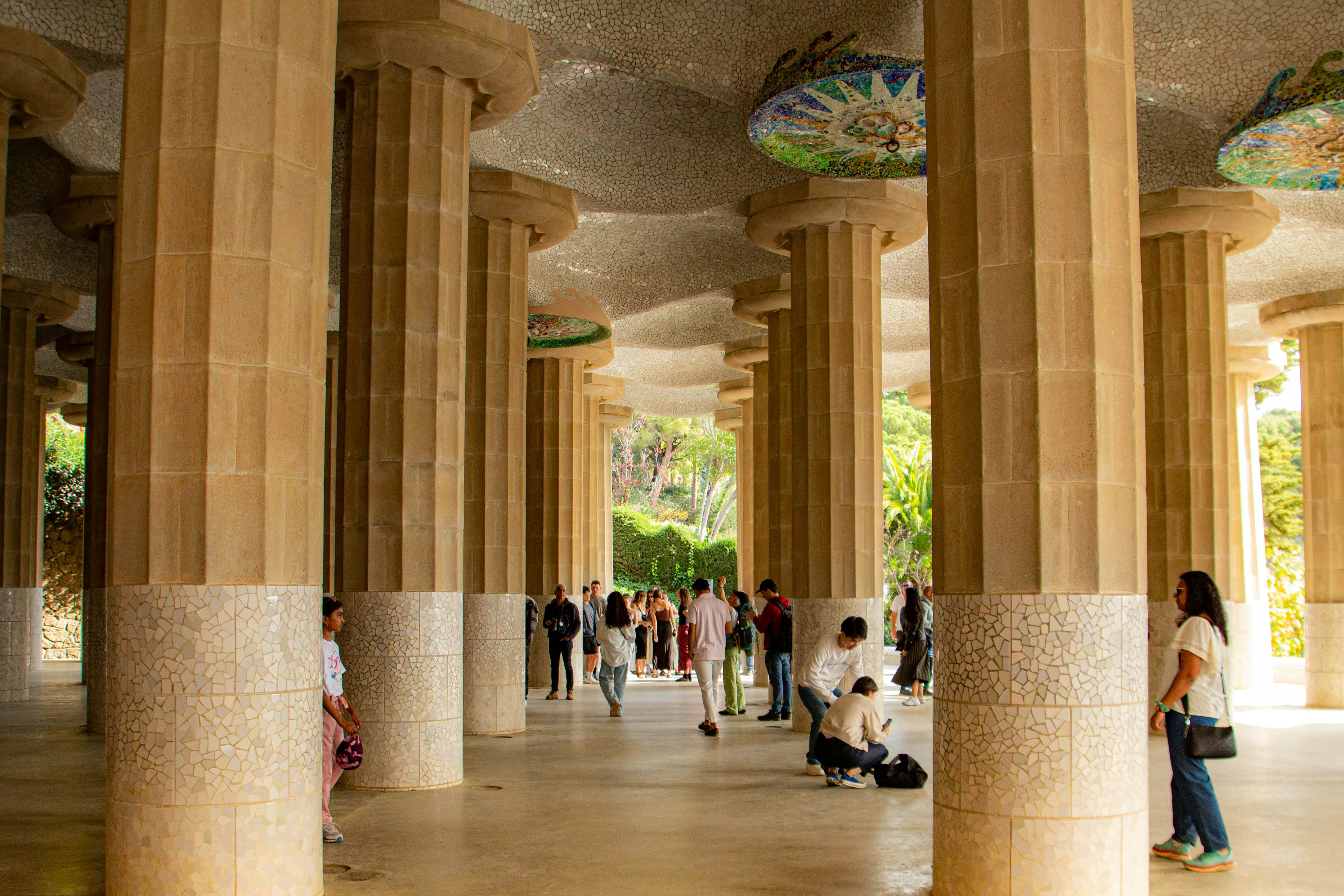 Colonnade at Leisure: People Gather Beneath Sunlit Columns